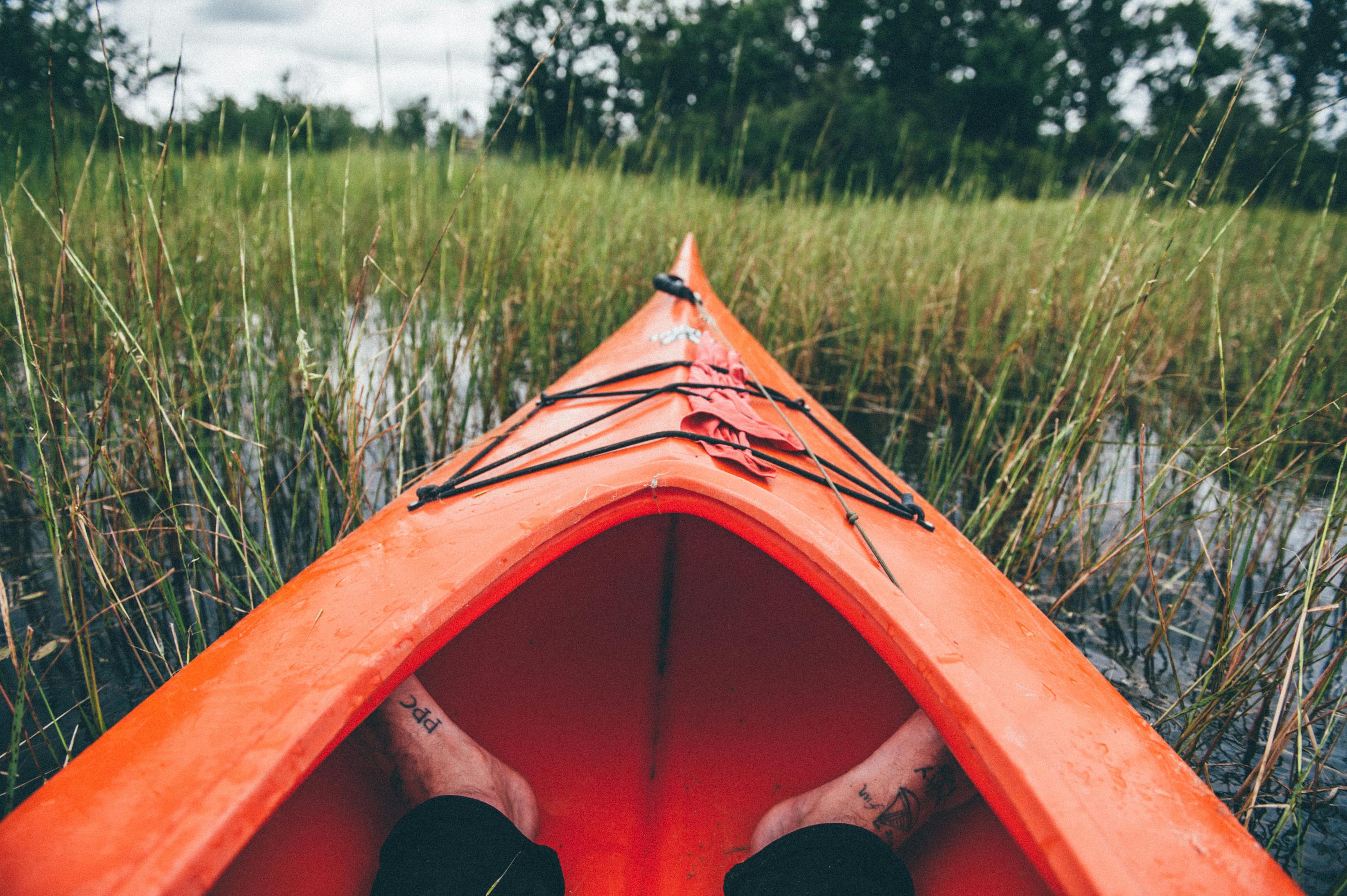 Feet on Red Kayak Boat · Free Stock Photo