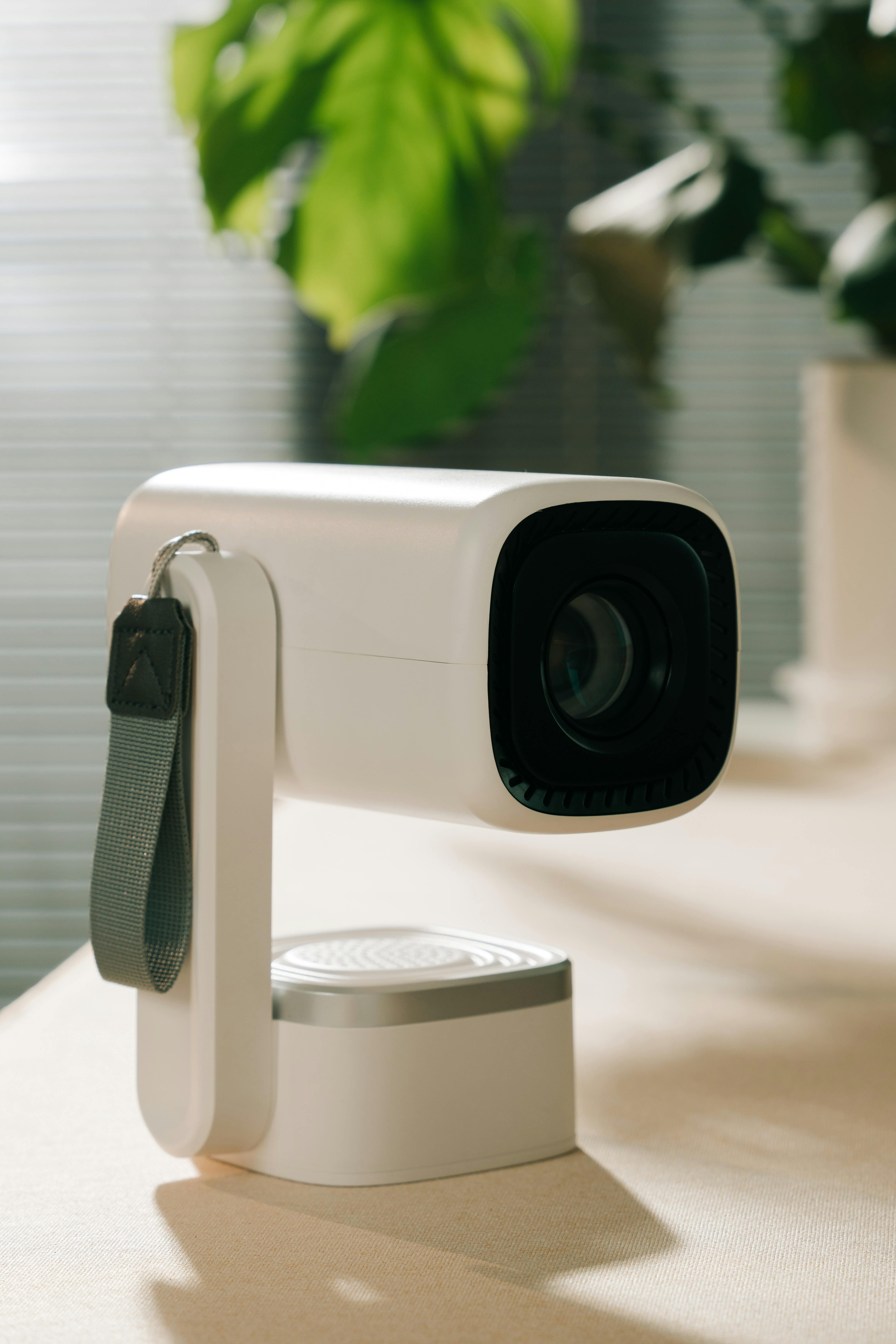Modern Compact Projector with Strap on Desk · Free Stock Photo