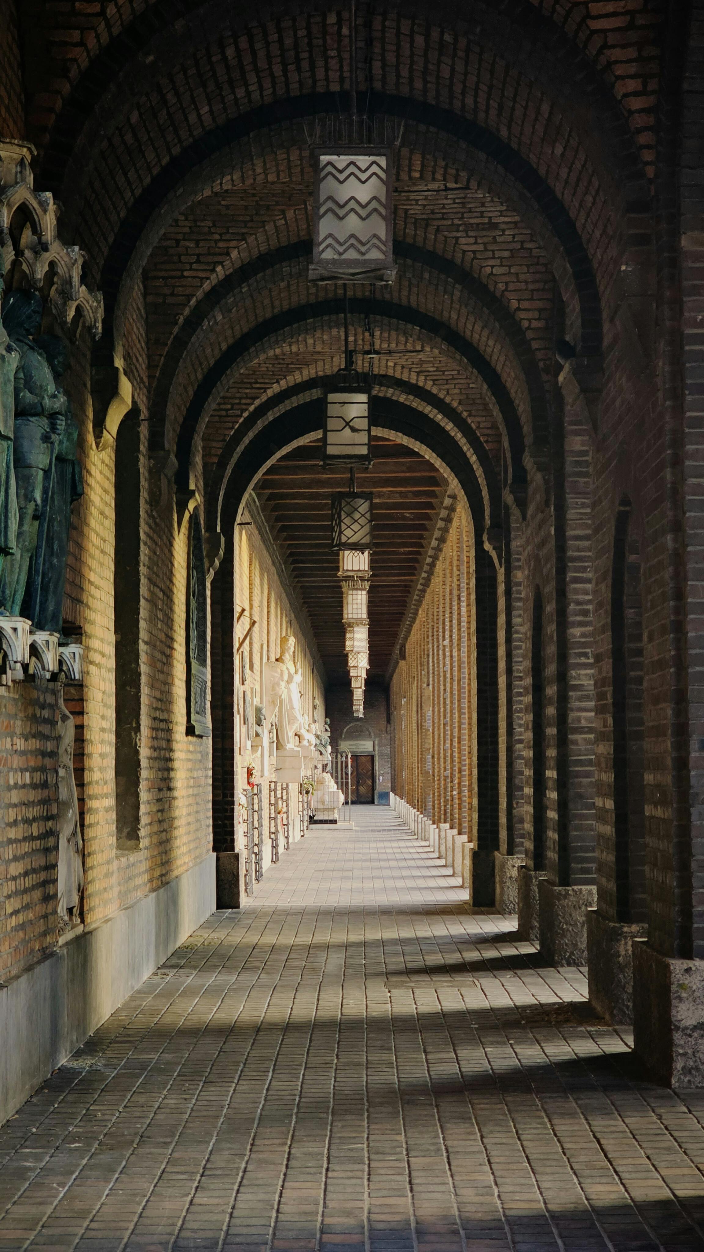 Historic Brick Archway Corridor in Afternoon Light · Free Stock Photo