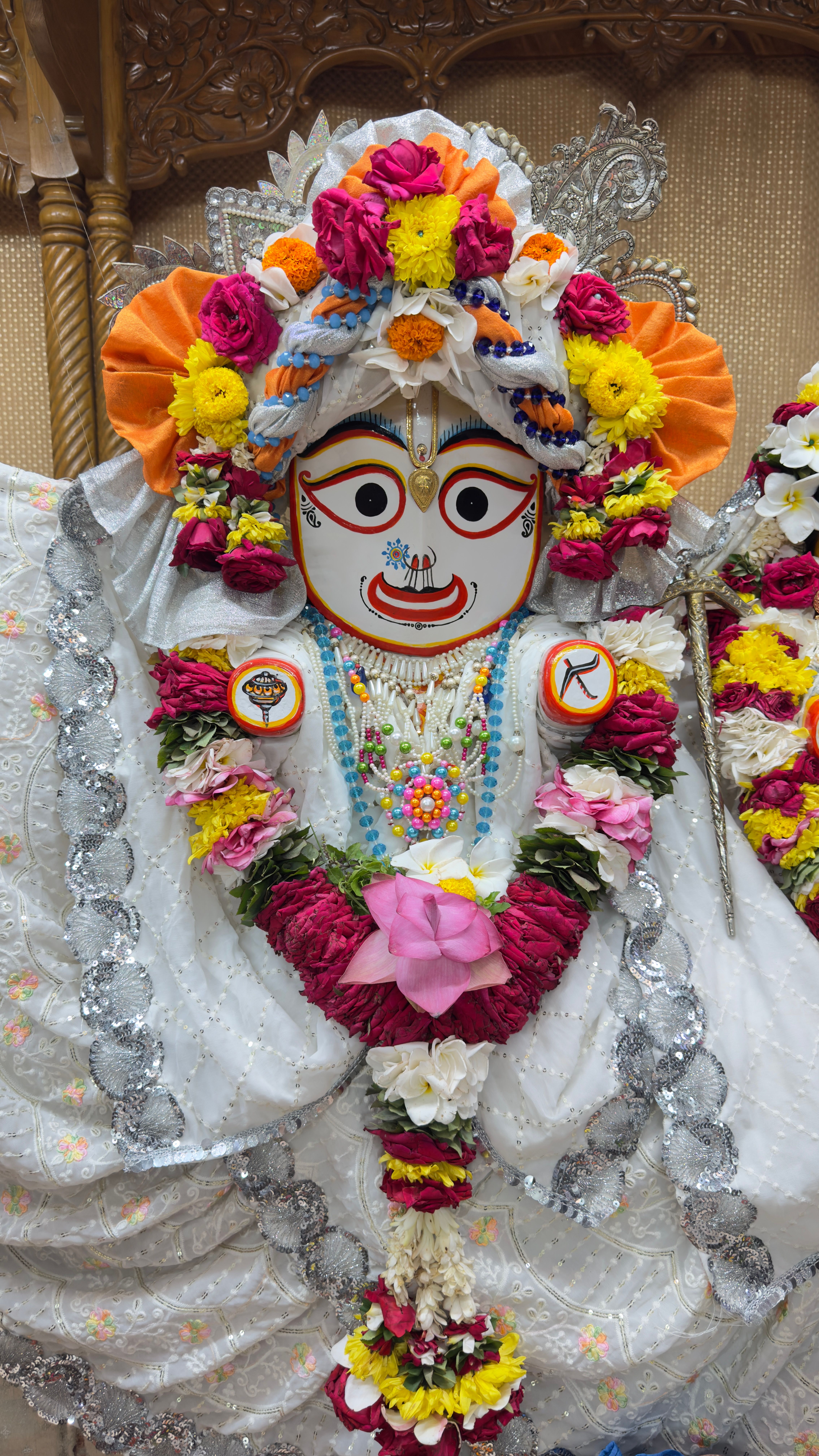 Vibrant Indian Deity Adorned with Flowers and Jewelry · Free Stock Photo