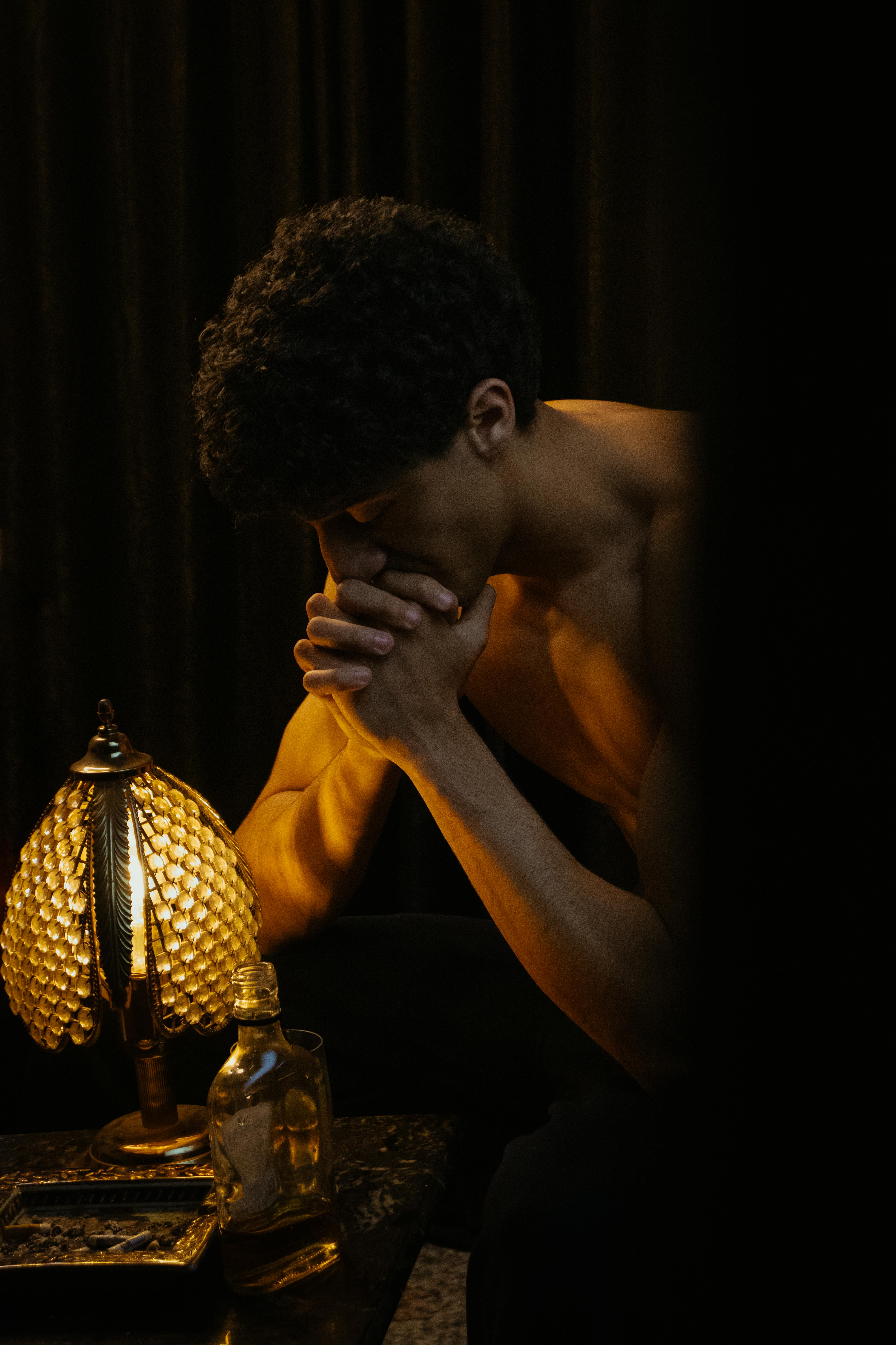 Moody Portrait of a Contemplative Man in Dim Lighting · Free Stock Photo