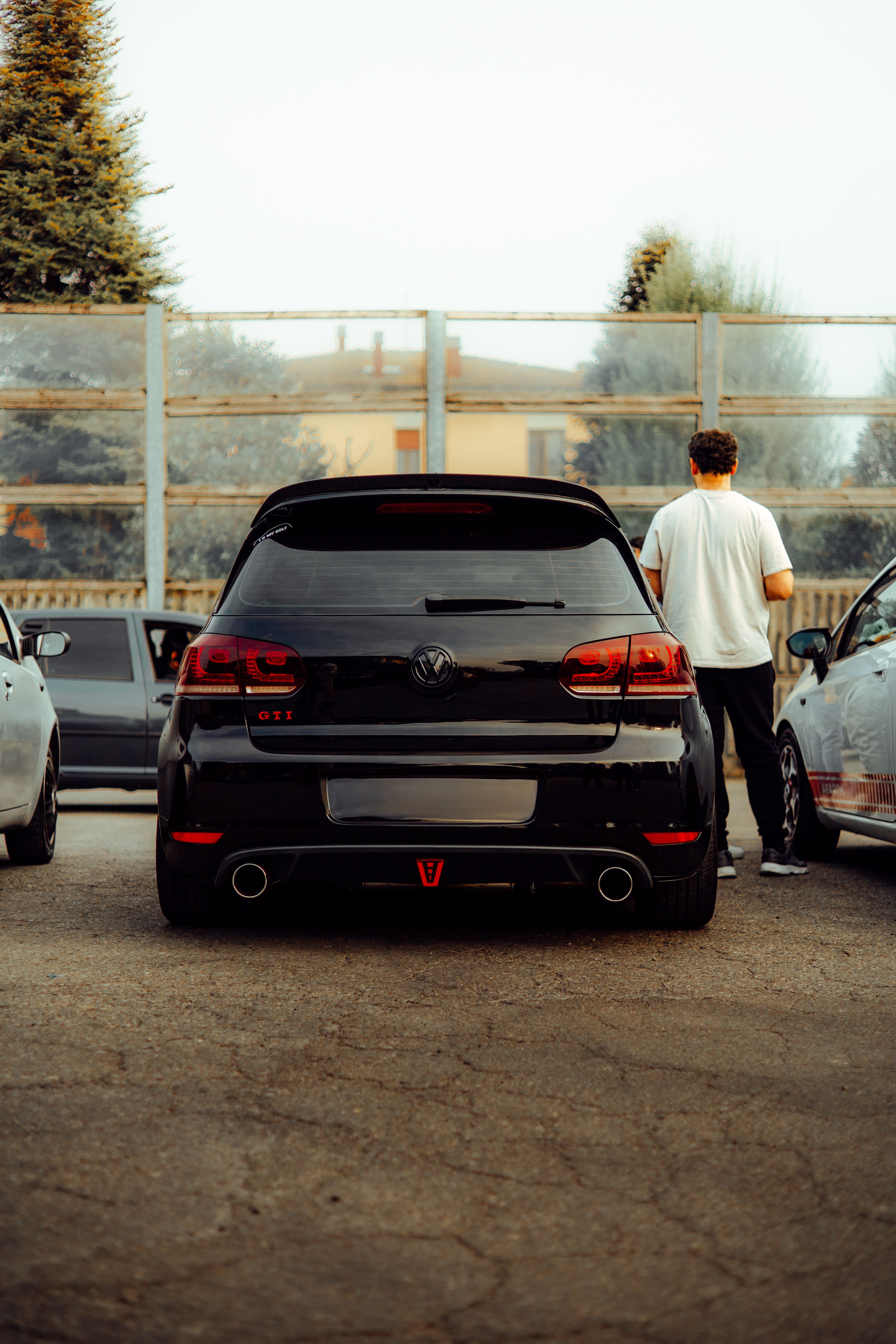 Black Car Parked with Person Nearby · Free Stock Photo