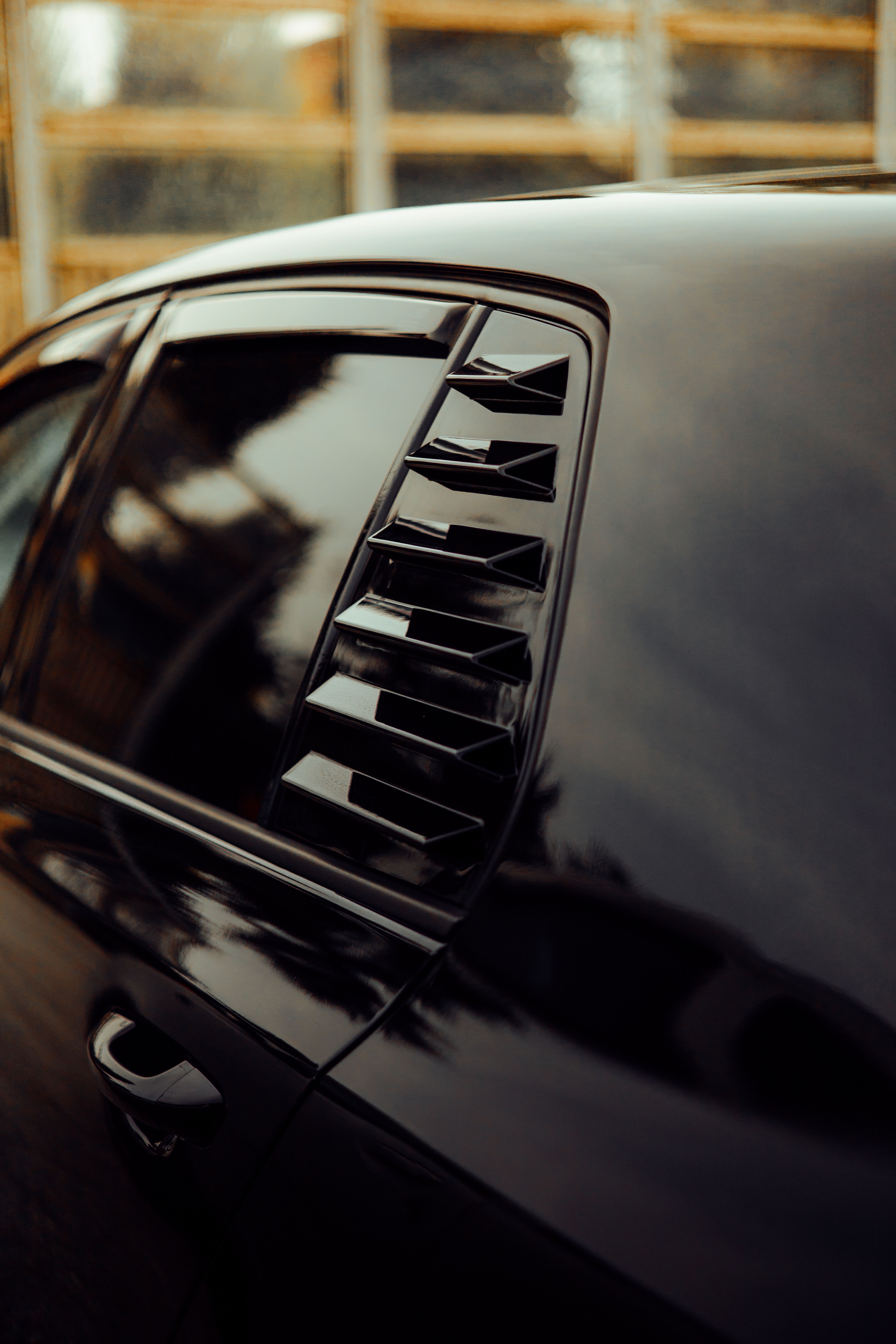 Sleek Black Car with Stylish Window Louvers · Free Stock Photo