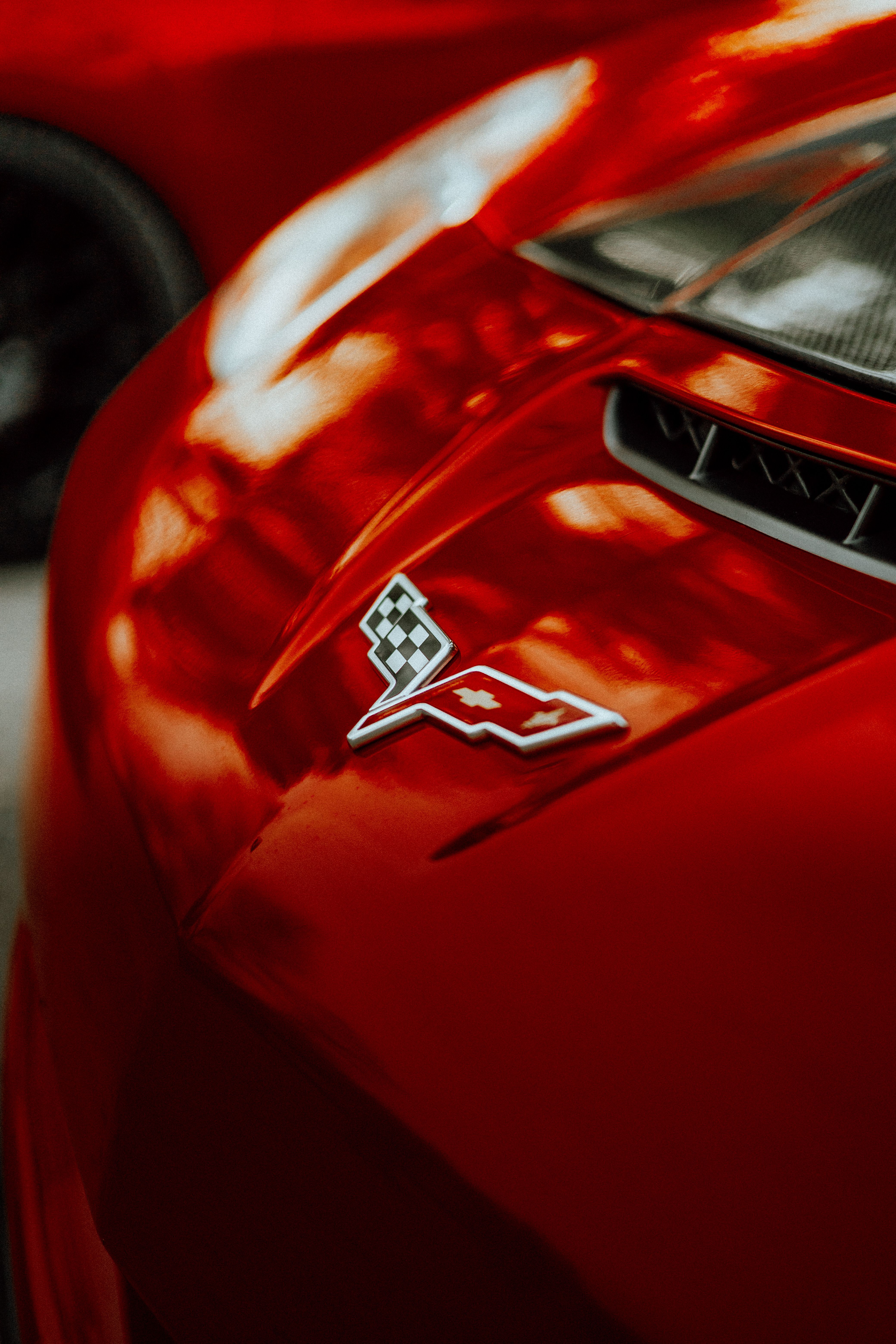 Close-Up of Red Sports Car Emblem · Free Stock Photo