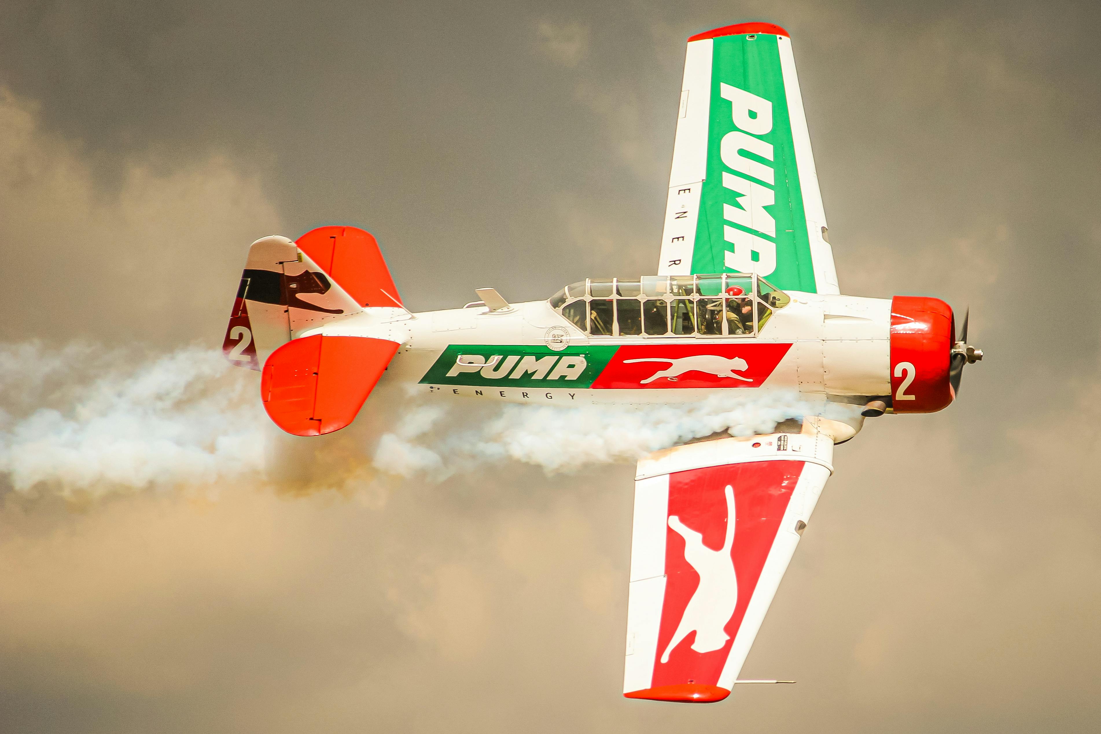 Aerobatic Plane with Puma Branding Performing Airshow · Free Stock Photo