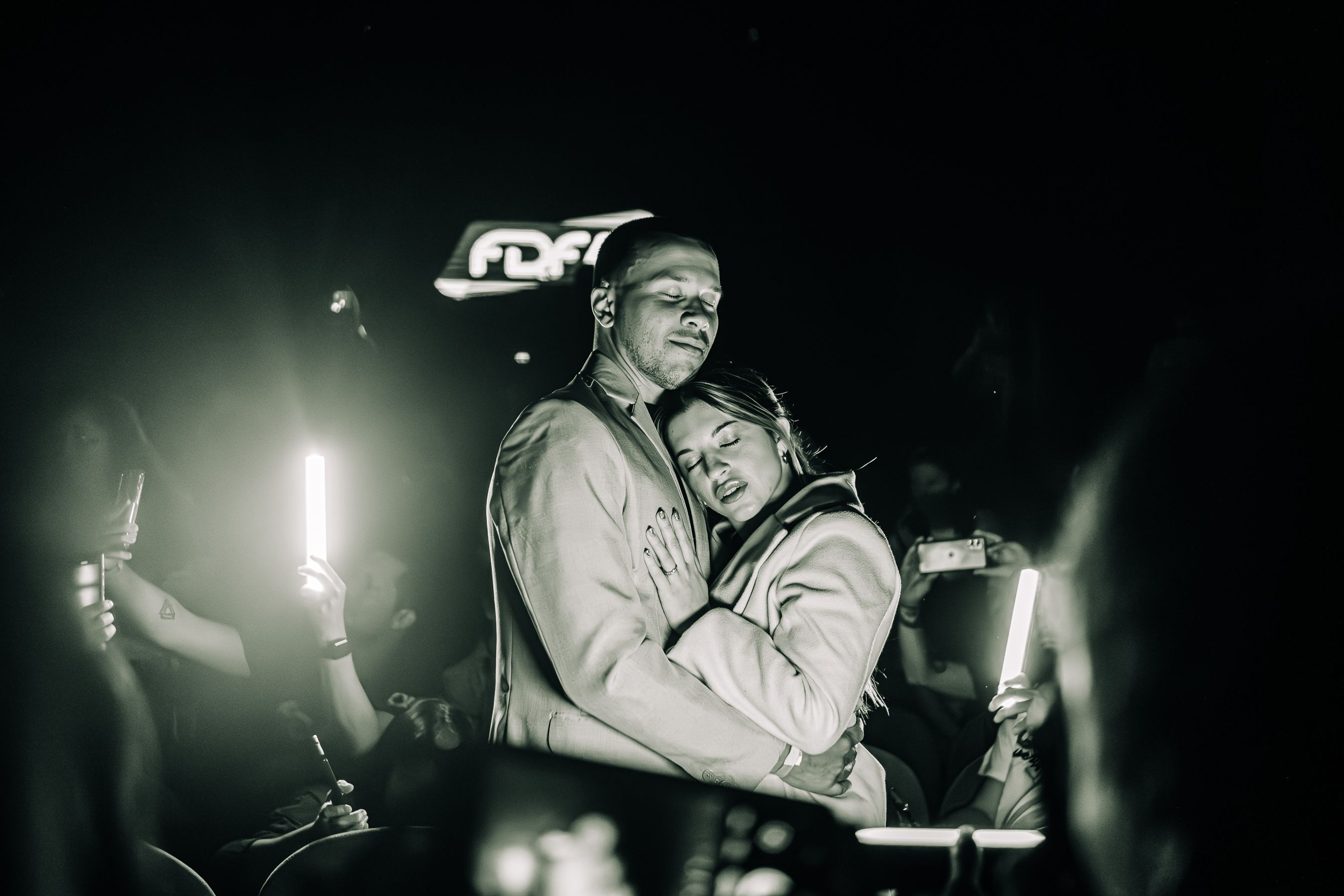 Couple Embracing at Night Club with Neon Lights · Free Stock Photo