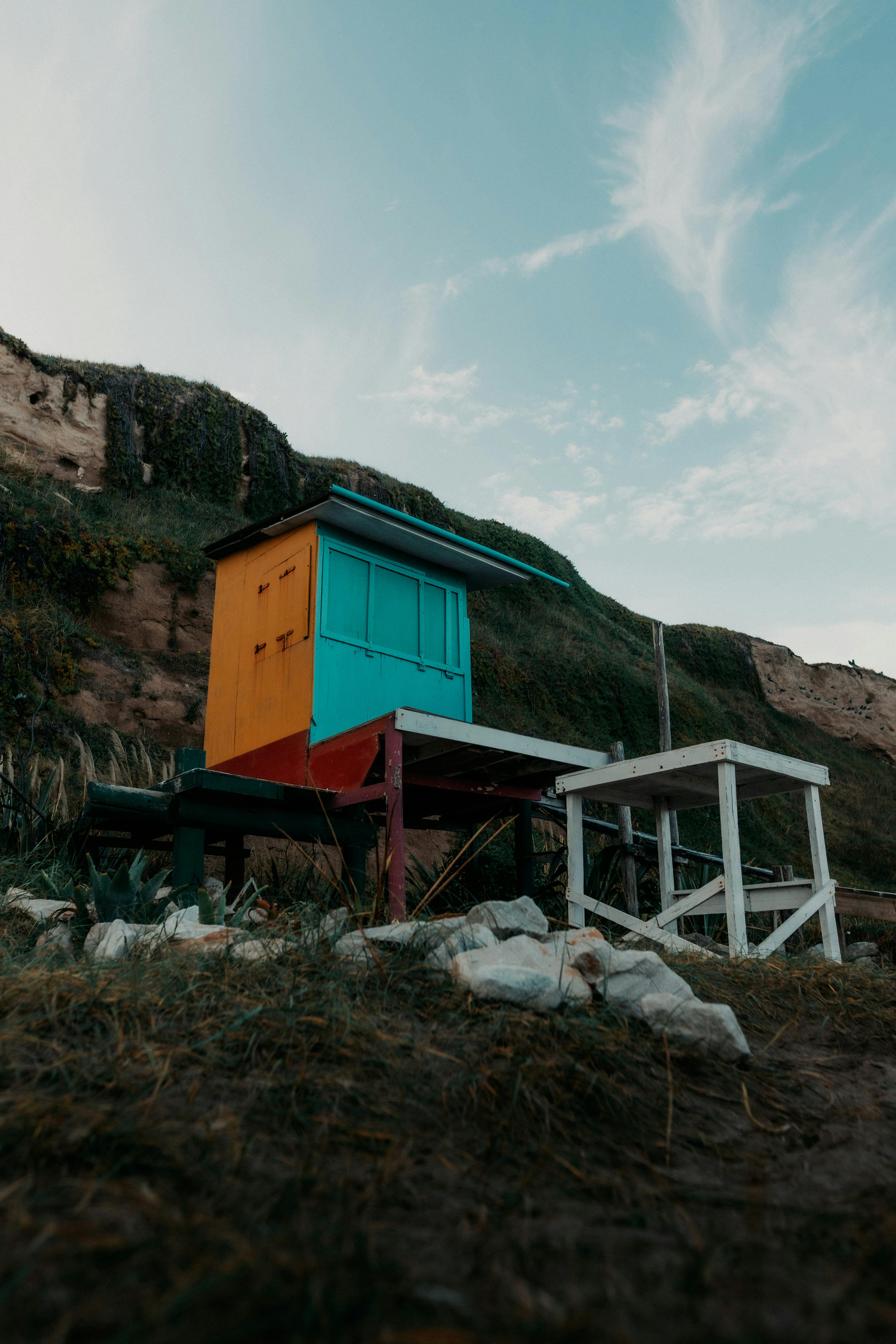 Colorful Beach Hut on a Cliffside in Summer · Free Stock Photo