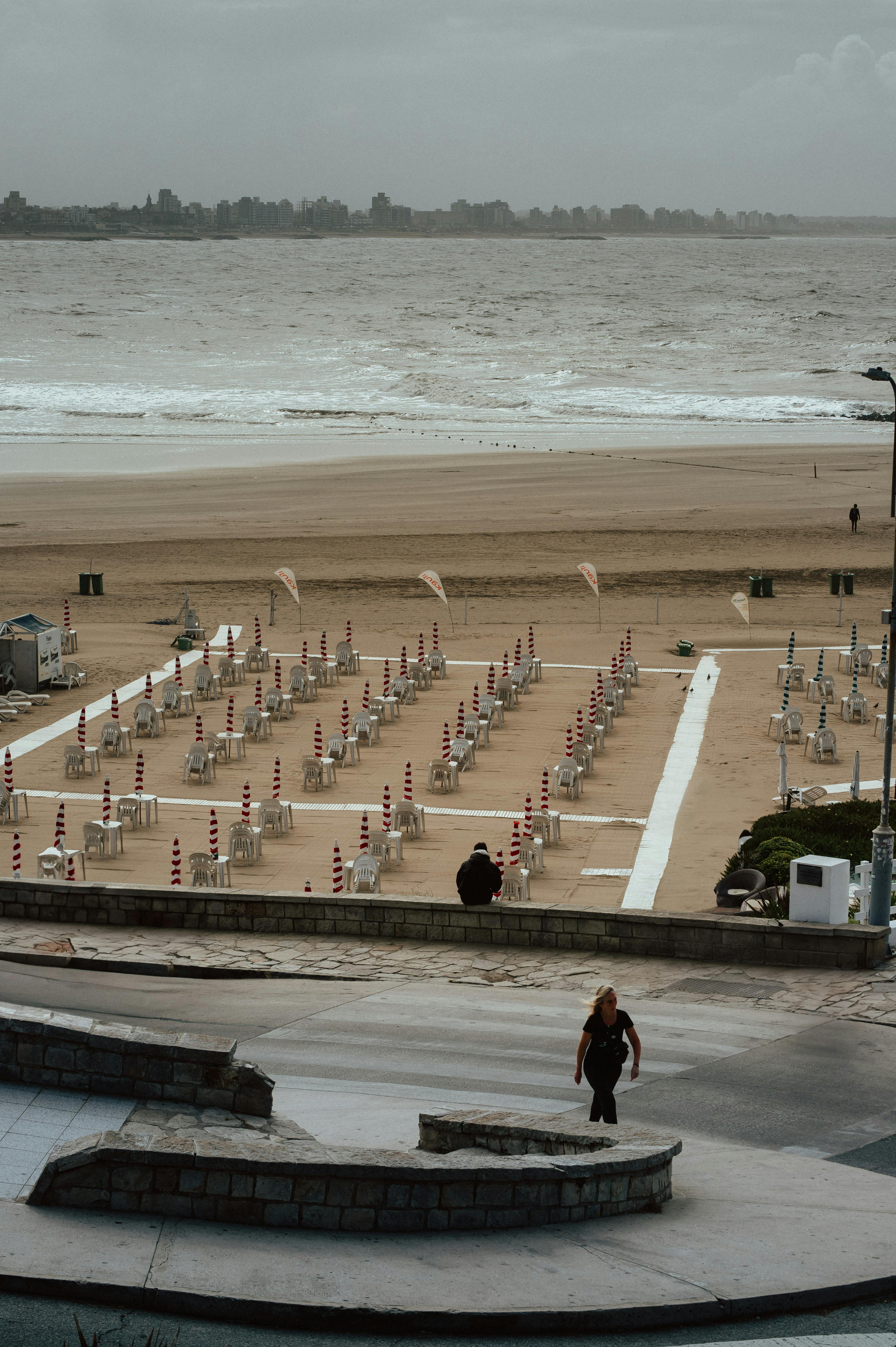 Quiet Beachfront with Closed Umbrellas and Empty Chairs · Free Stock Photo