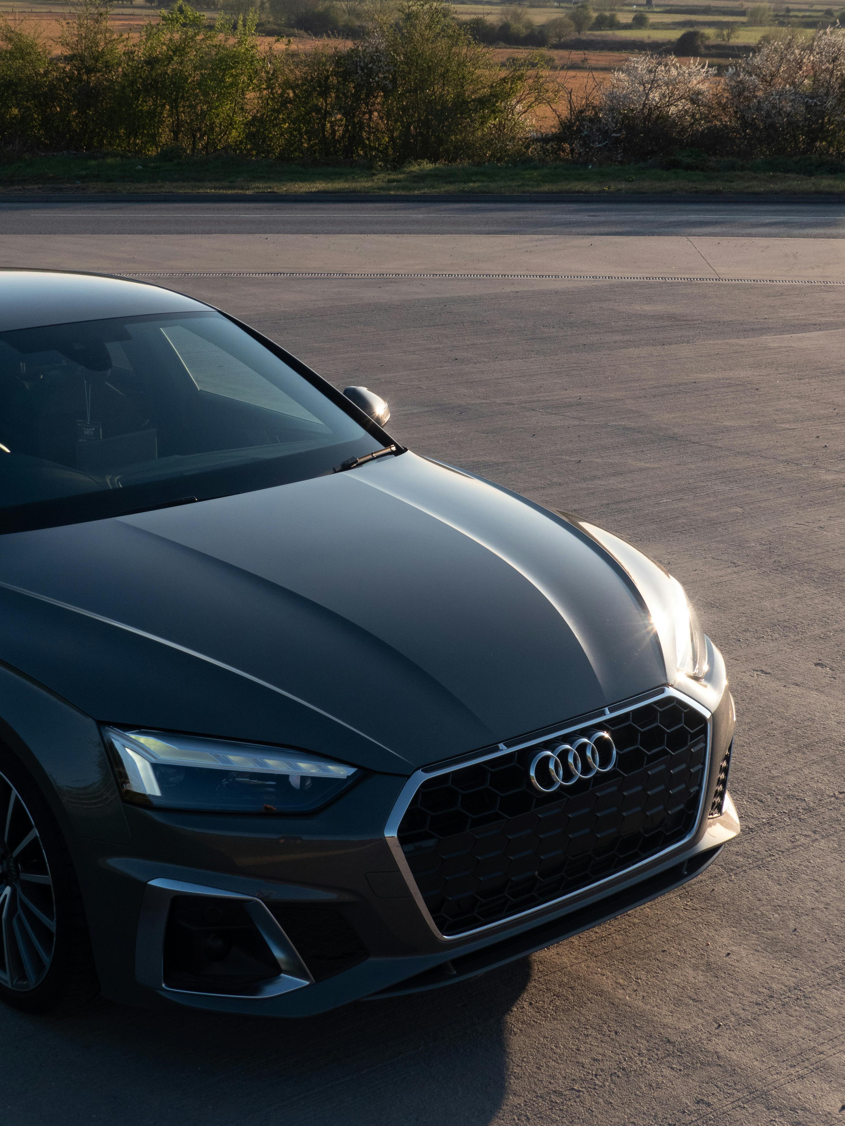 Sleek Audi Car in Scenic Sunset Driveway · Free Stock Photo