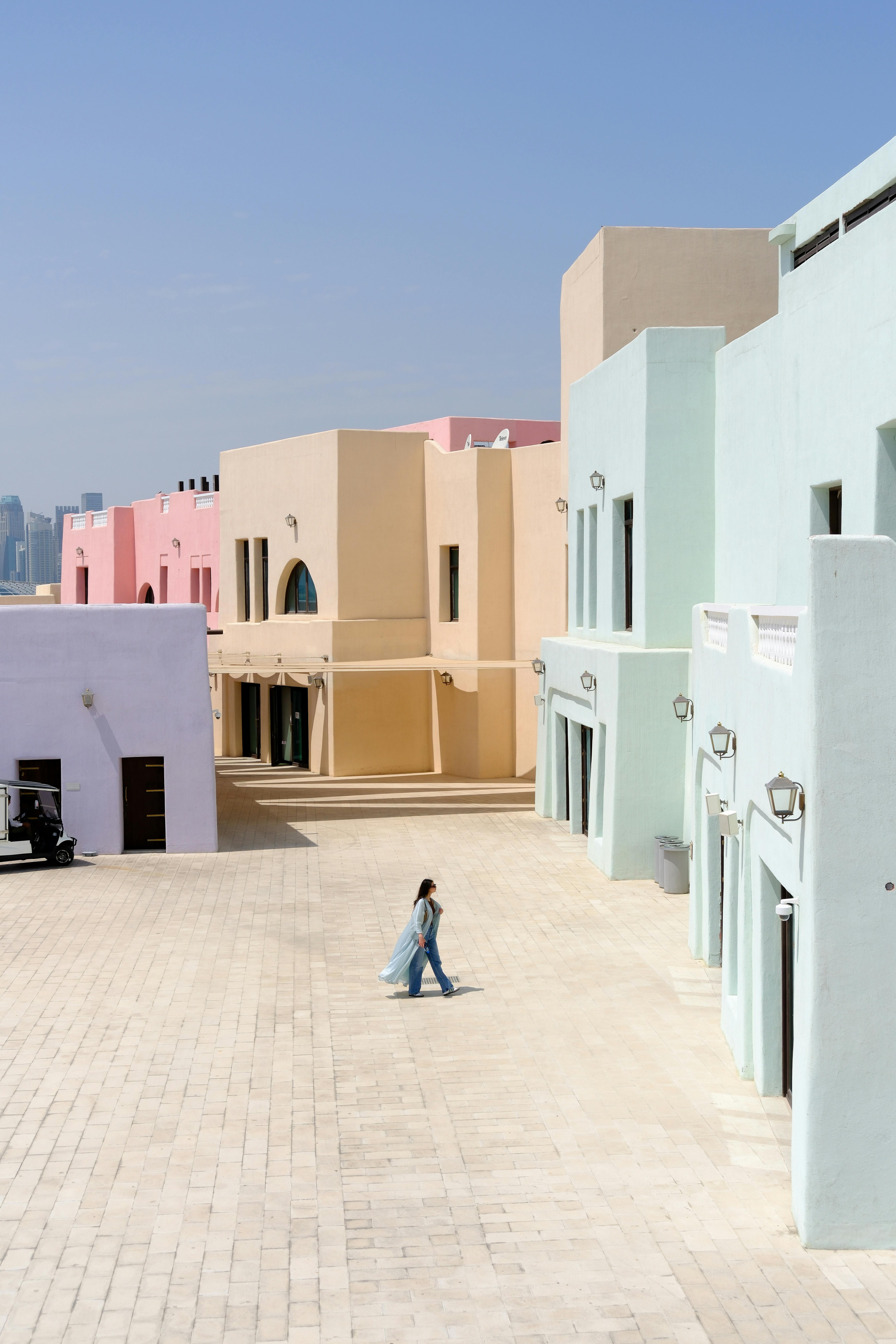 Pastel-Colored Buildings in Sunlit Urban Setting · Free Stock Photo