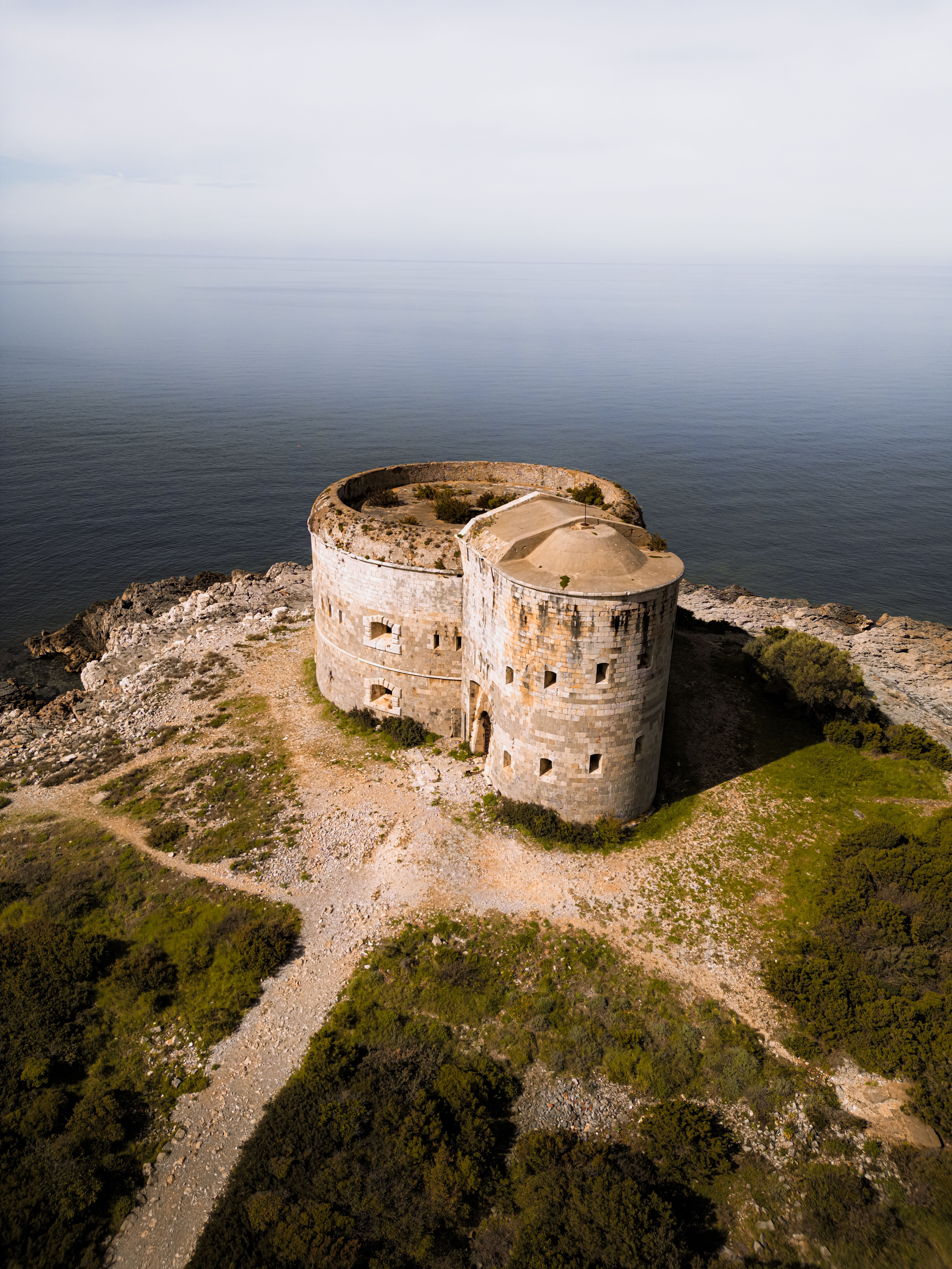 Historic Coastal Fort on Rocky Cliff · Free Stock Photo