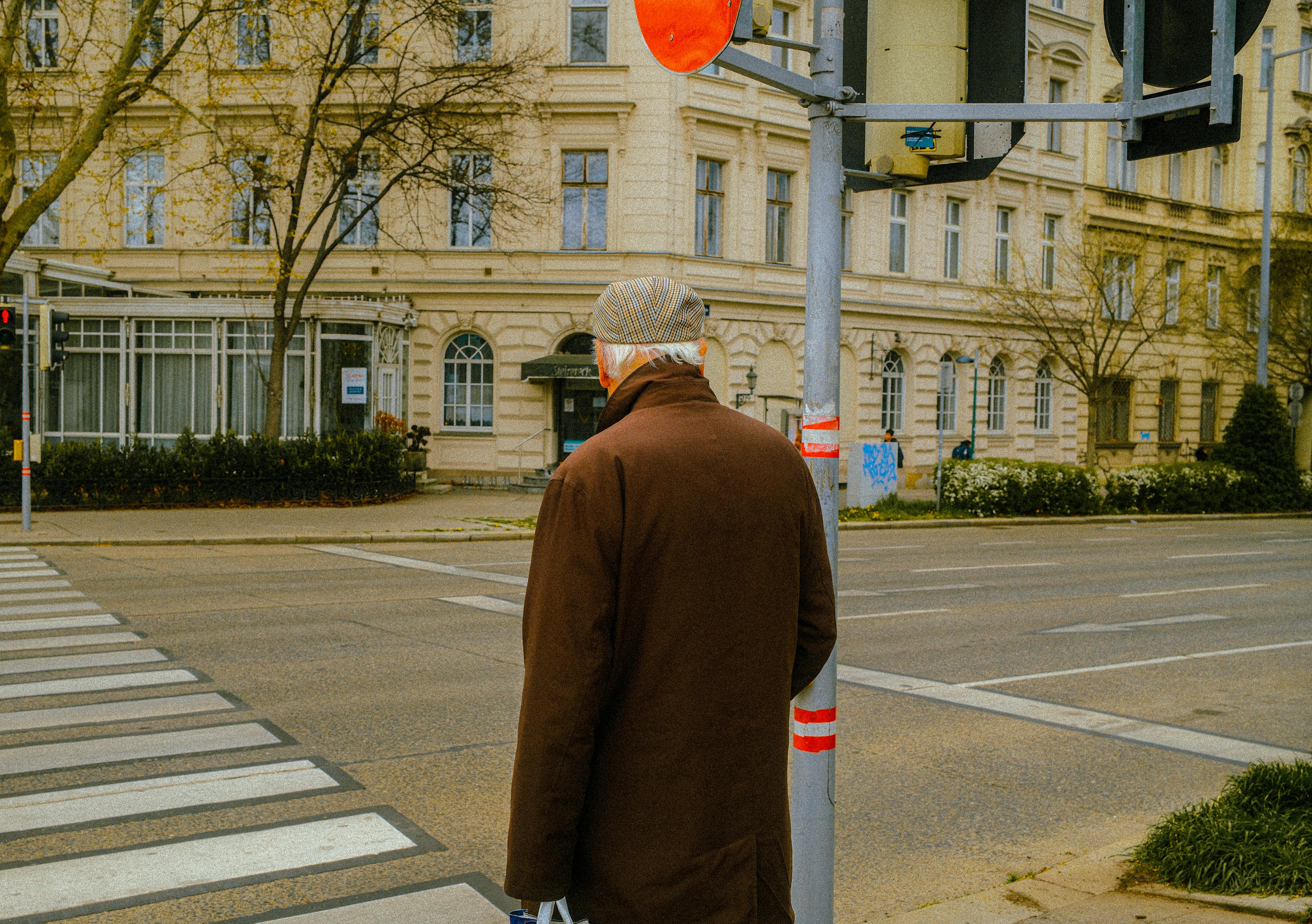 Elderly Man Waiting at Urban Crosswalk · Free Stock Photo