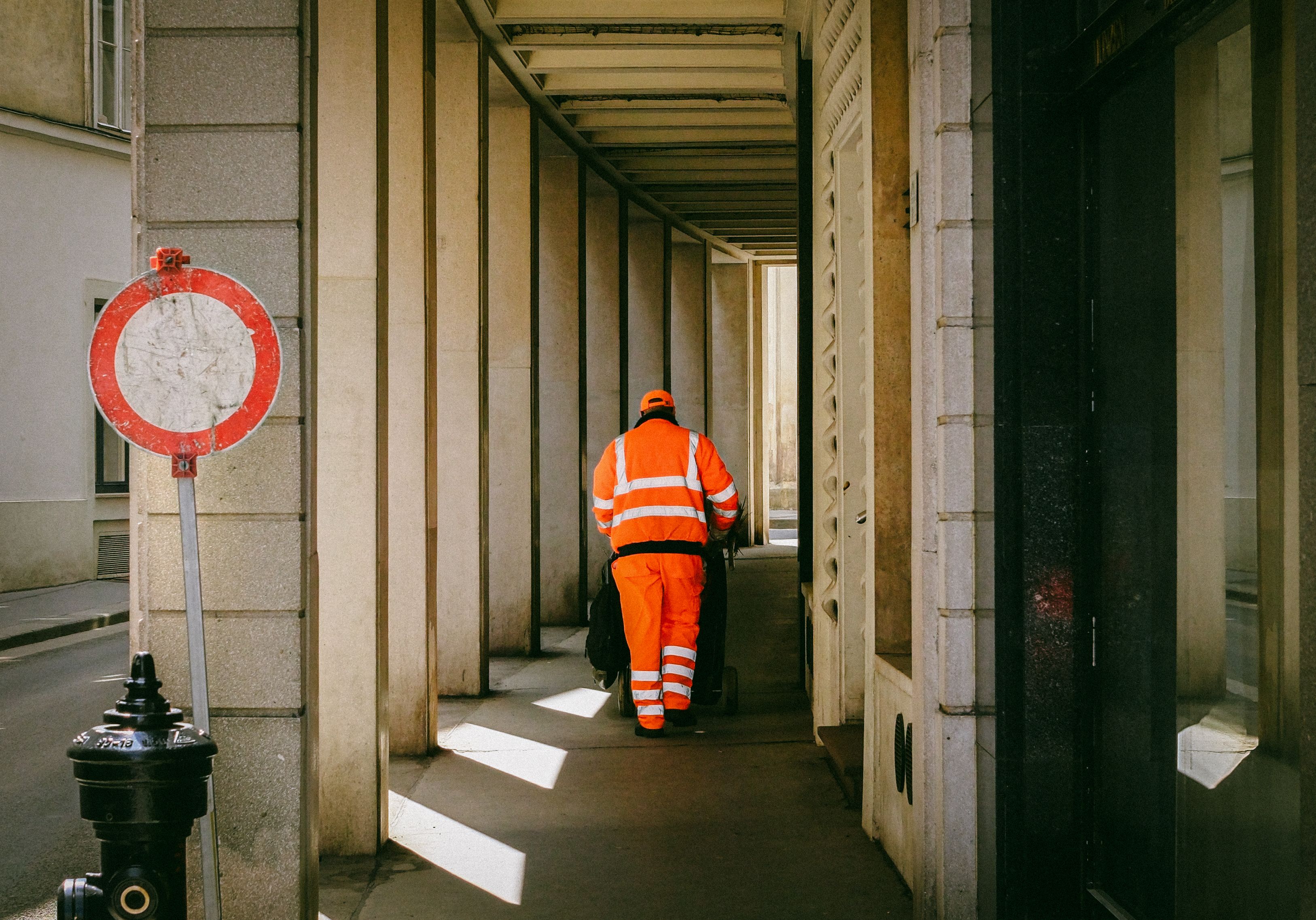 Street Worker in Bright Orange Uniform Walking · Free Stock Photo