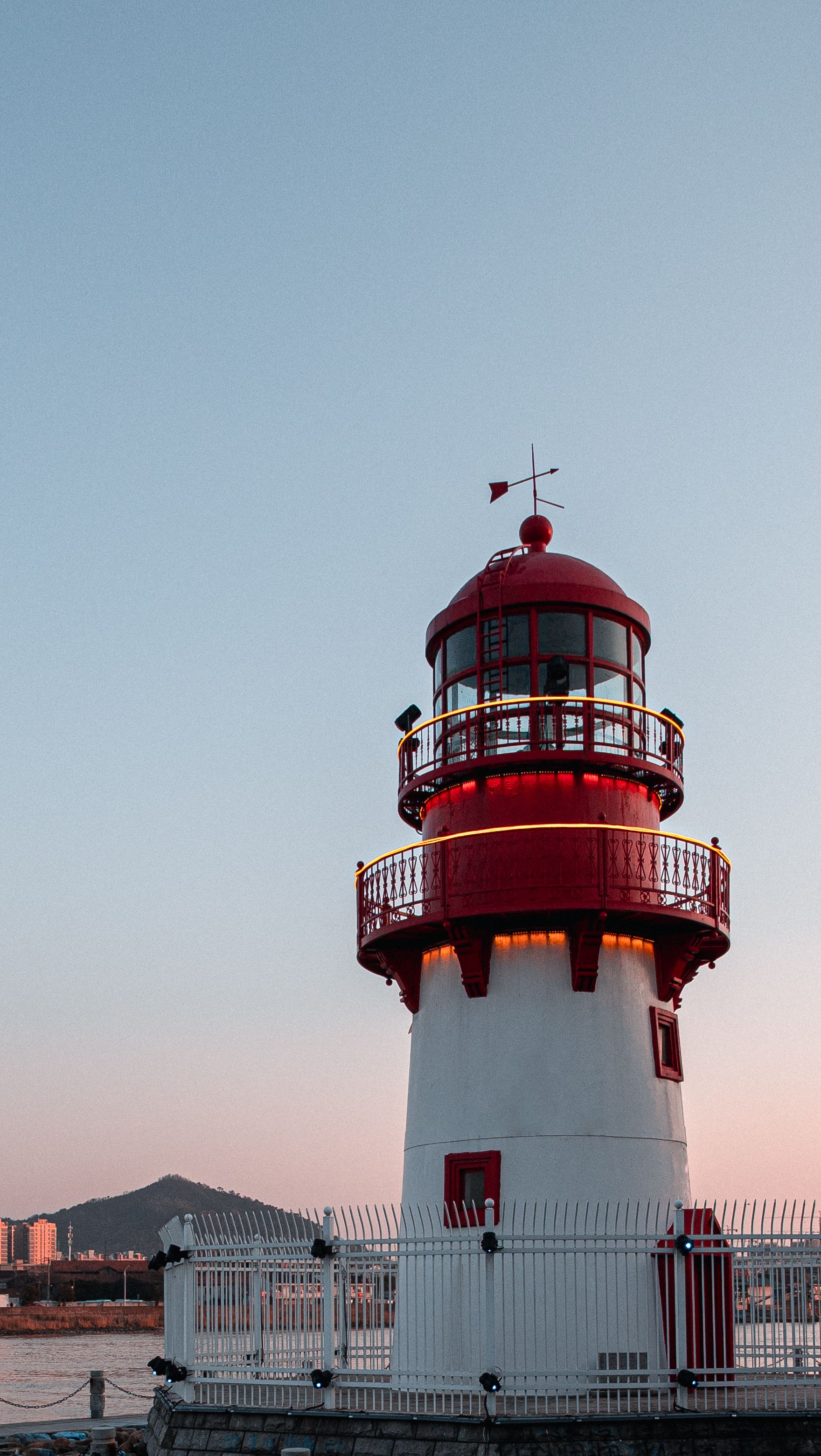 Scenic Lighthouse at Sunset by the Coast · Free Stock Photo