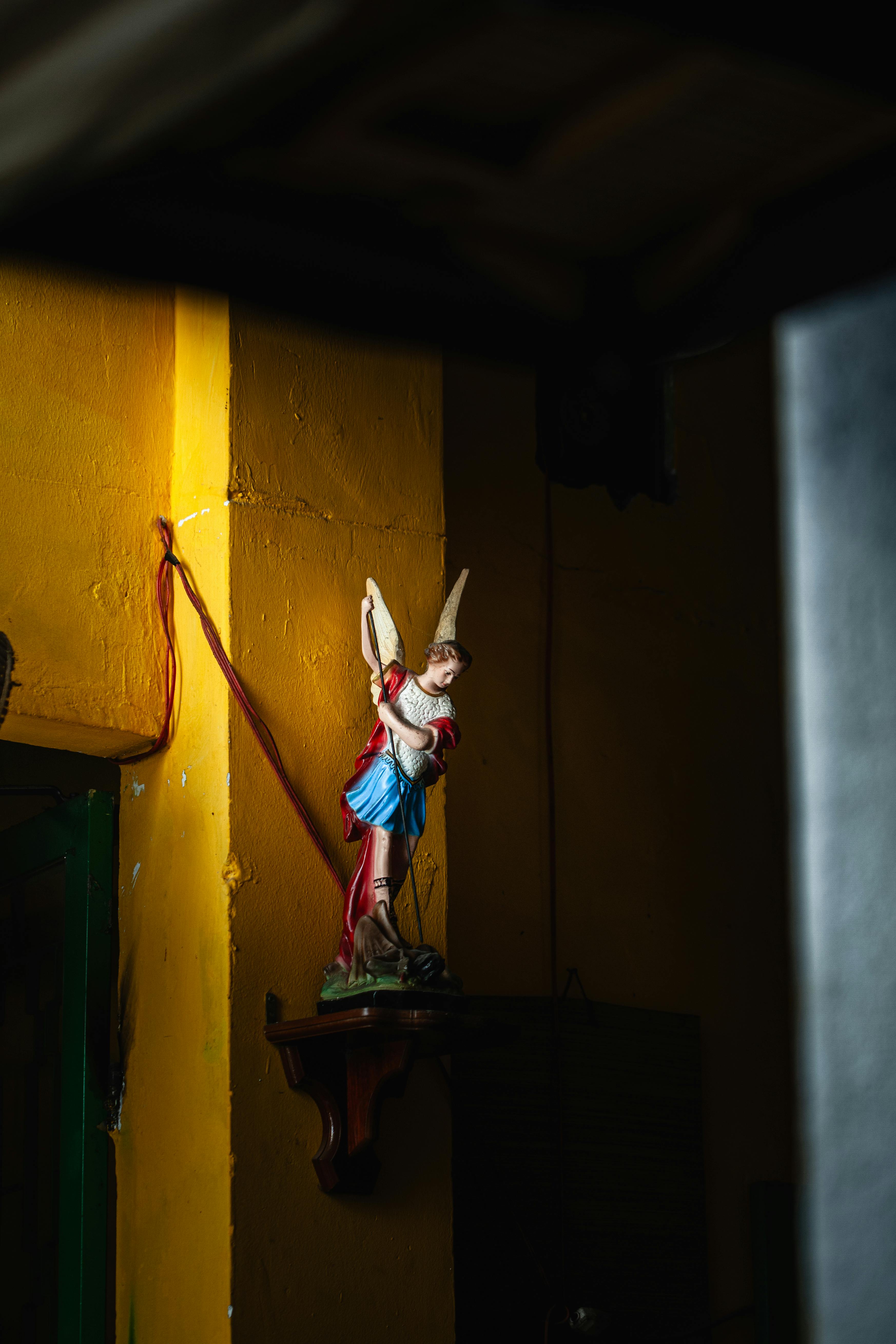 Dramatic Statue of Angel in Shadowed Interior · Free Stock Photo