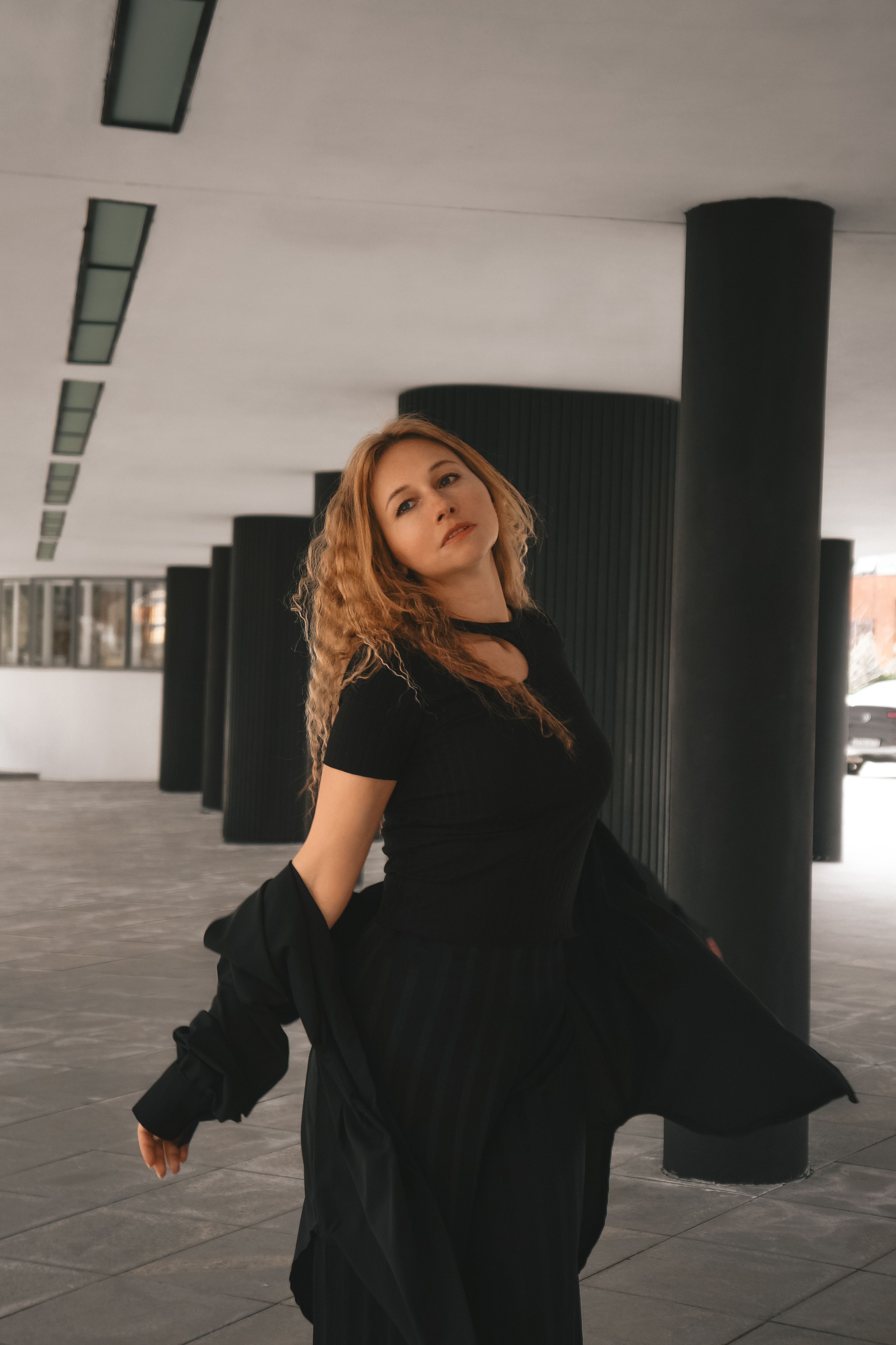 Stylish Woman Posing Indoors in Modern Setting · Free Stock Photo