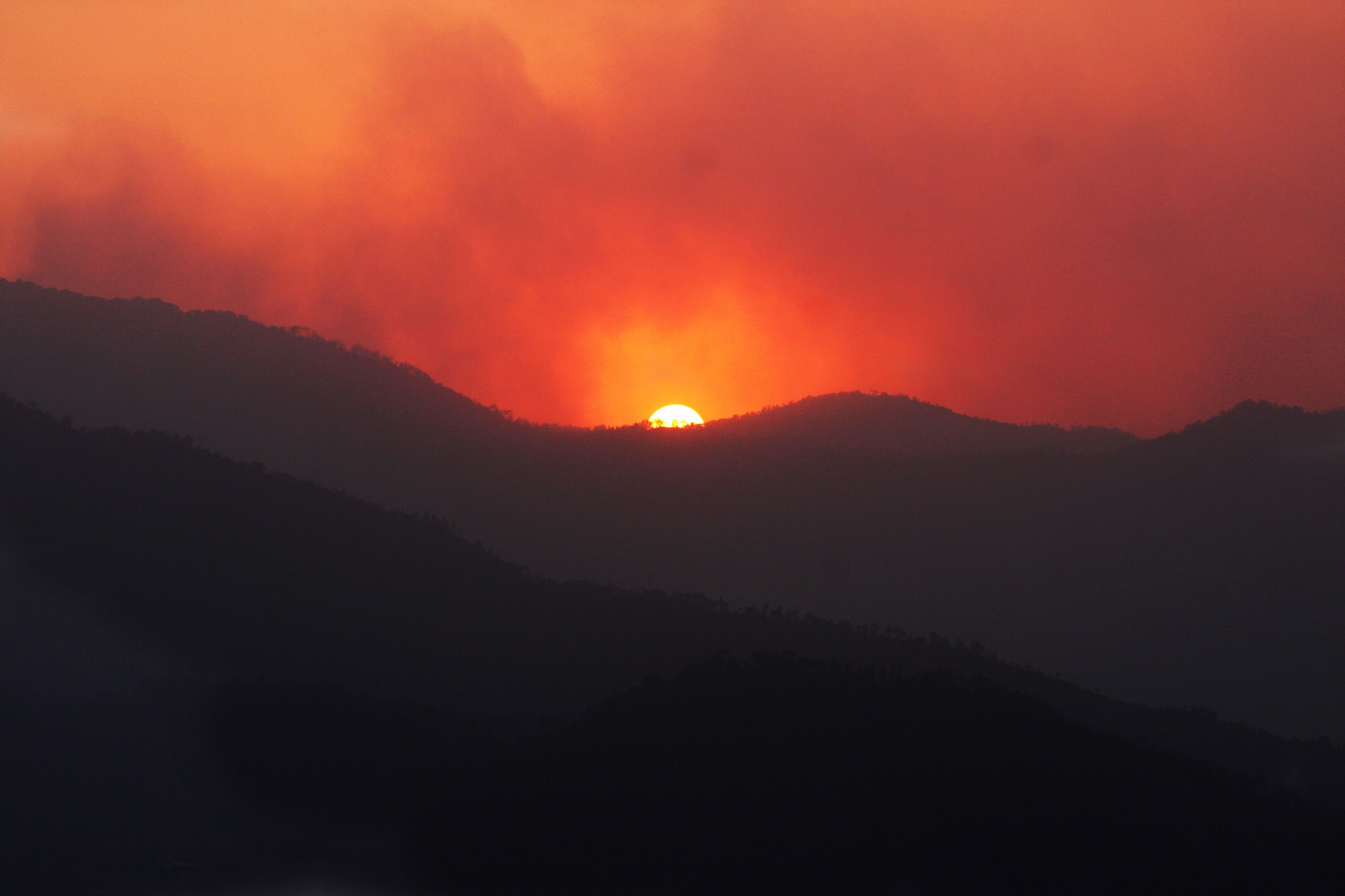Dramatic Sunset Over Misty Mountain Range · Free Stock Photo
