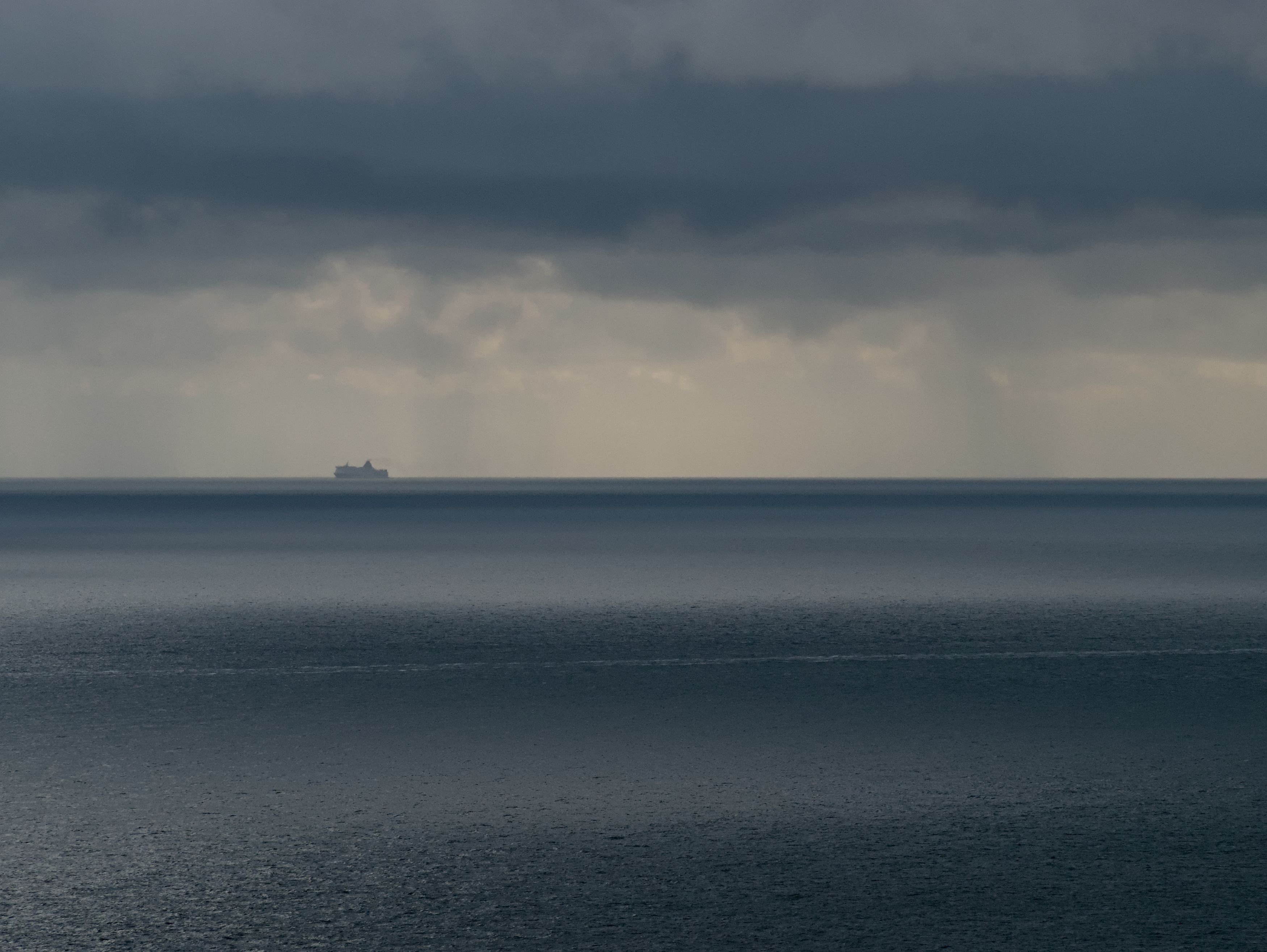 Dramatic Stormy Sea with Distant Ship · Free Stock Photo