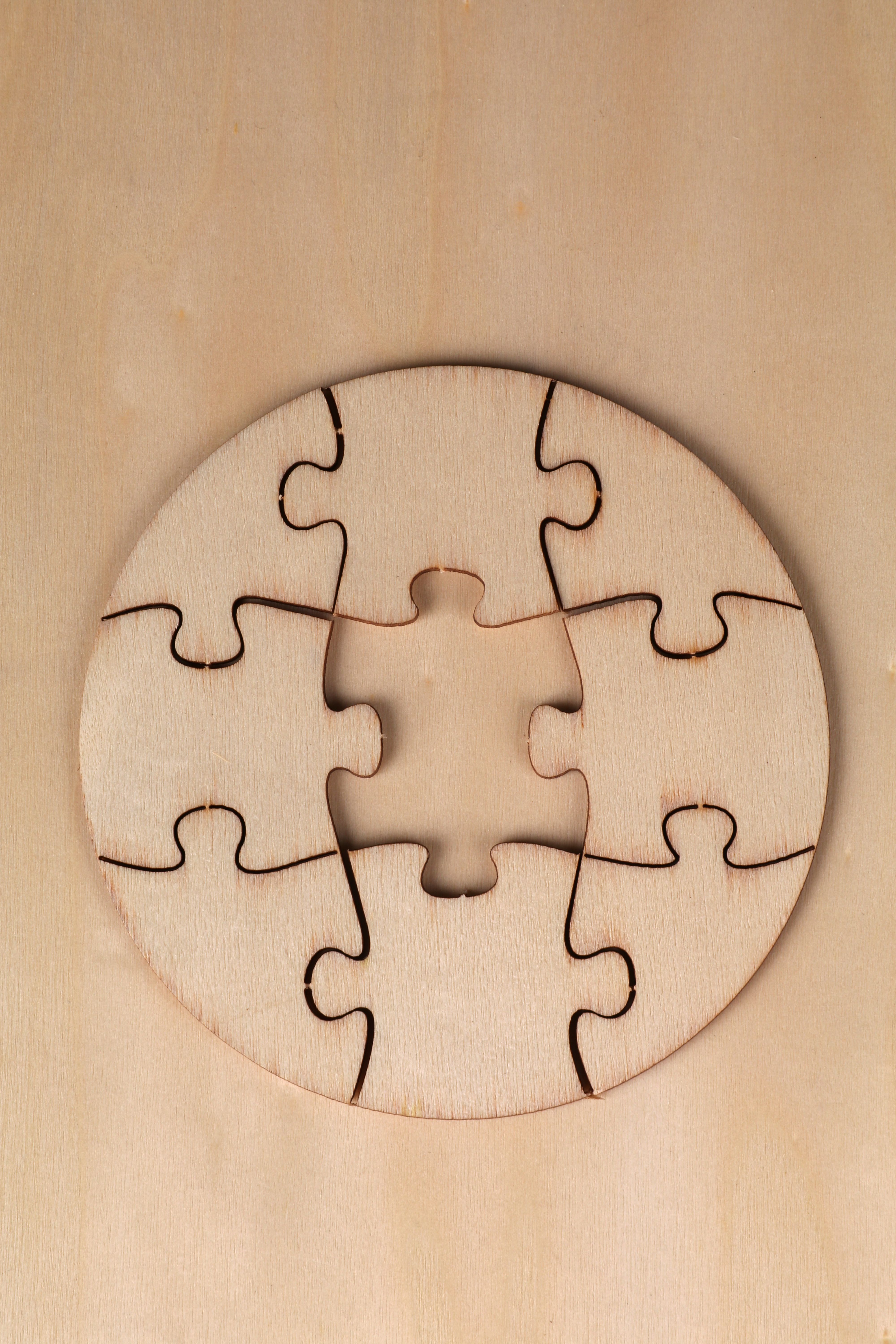 Round Wooden Puzzle on Wooden Background · Free Stock Photo
