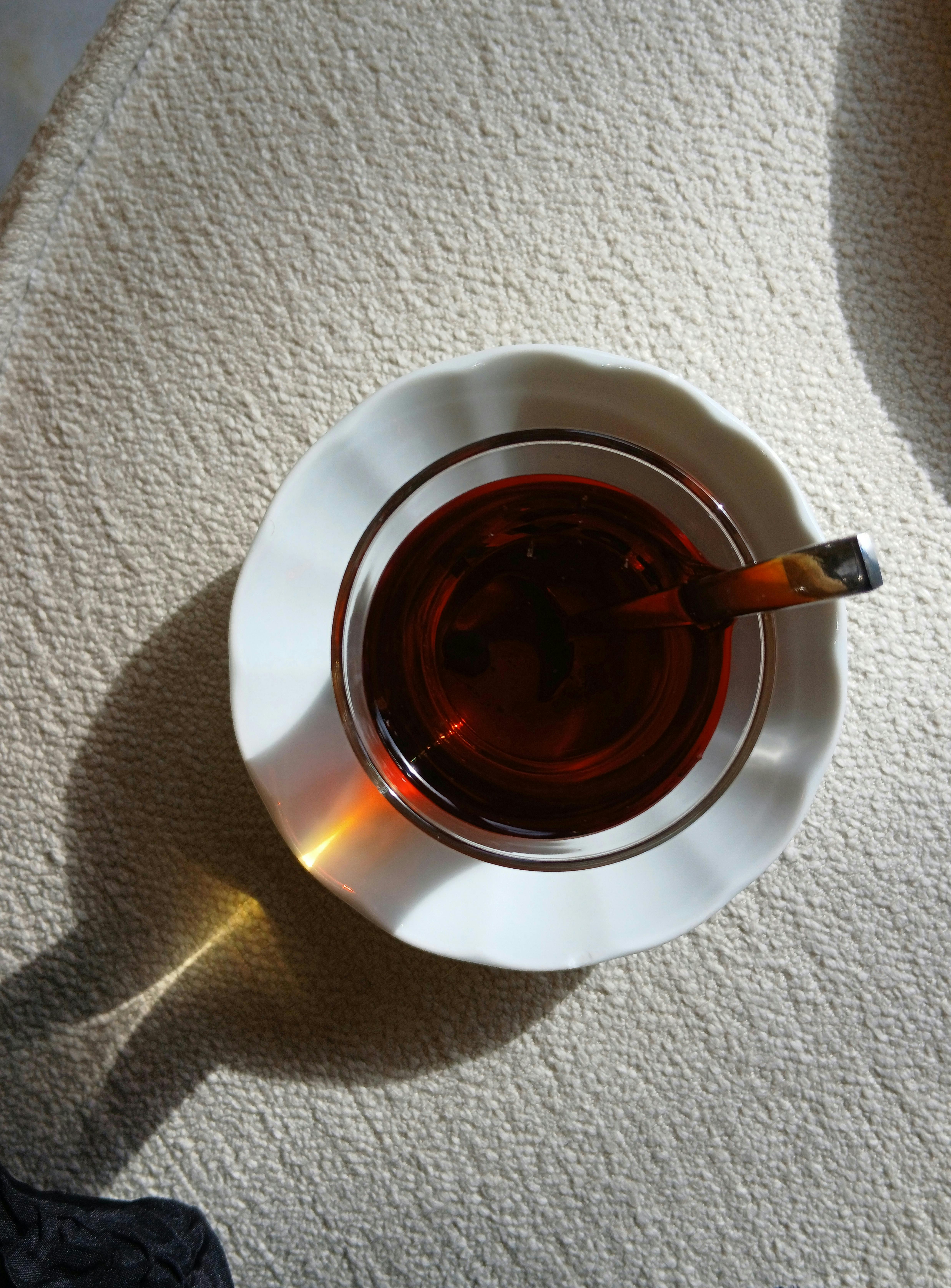 Top View of Black Tea in White Cup with Spoon · Free Stock Photo