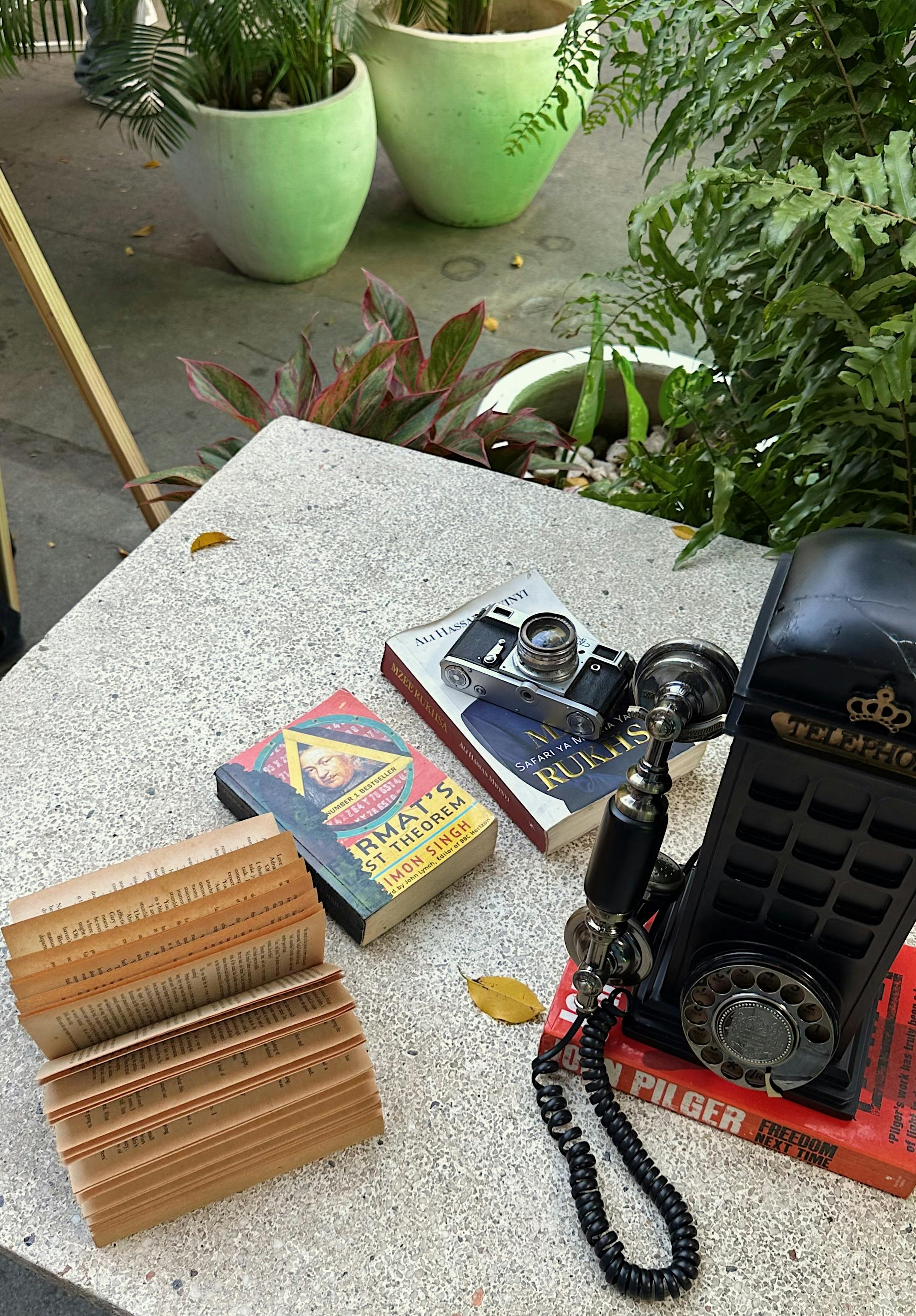 Vintage Camera and Books on Outdoor Table · Free Stock Photo
