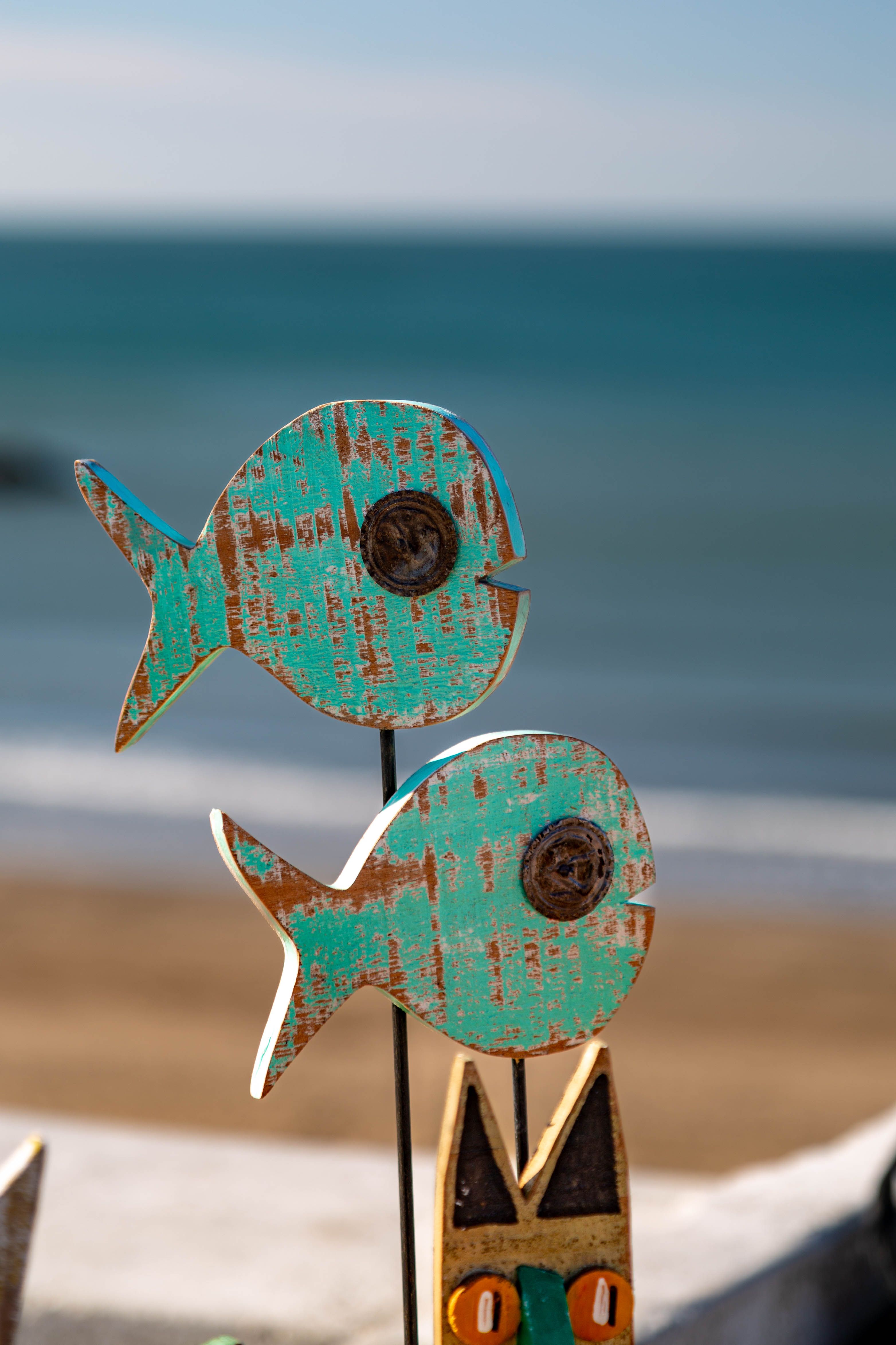 Colorful Wooden Fish Sculptures by the Sea · Free Stock Photo