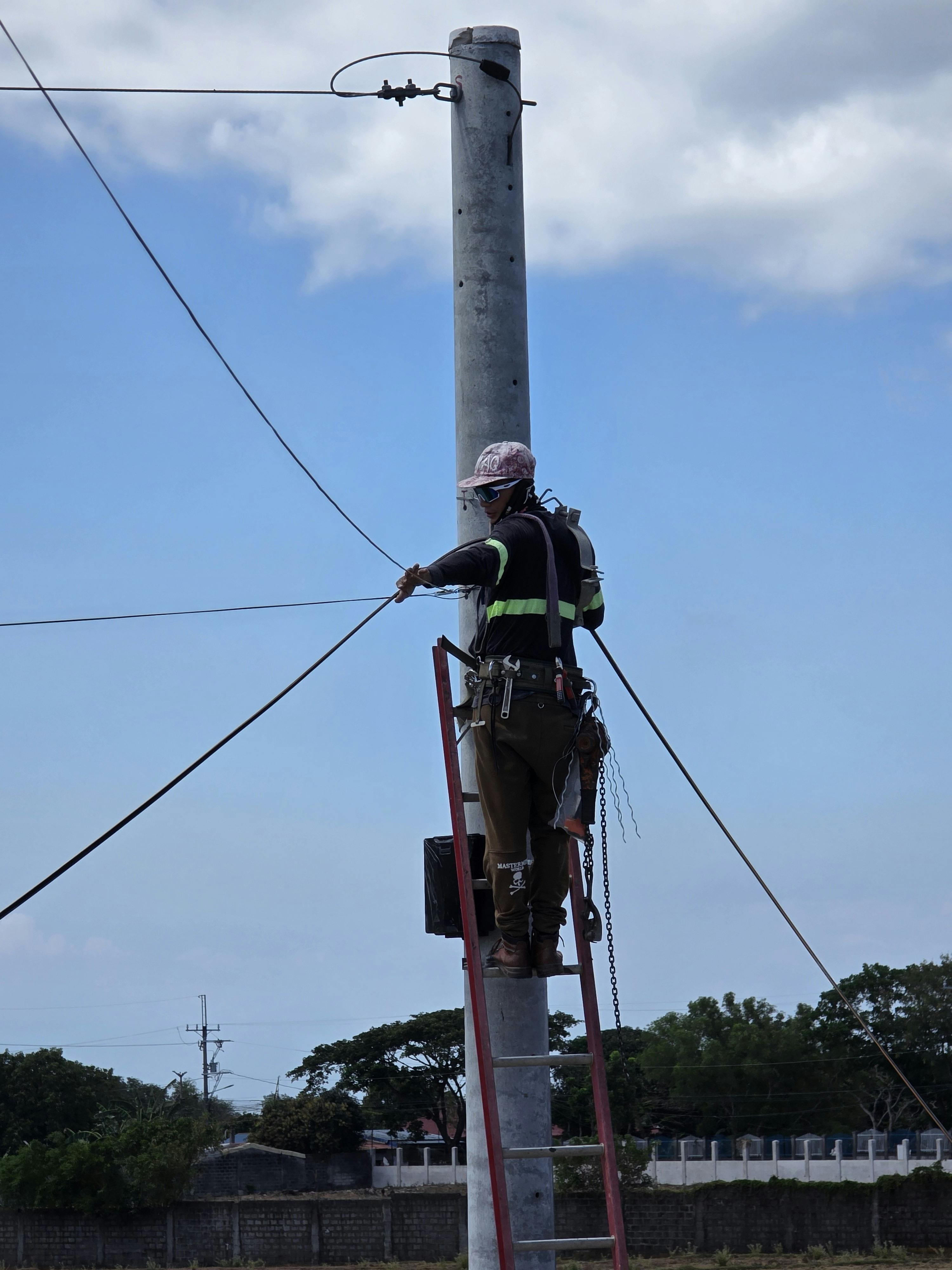 Lineman Working on Power Line Outdoors · Free Stock Photo
