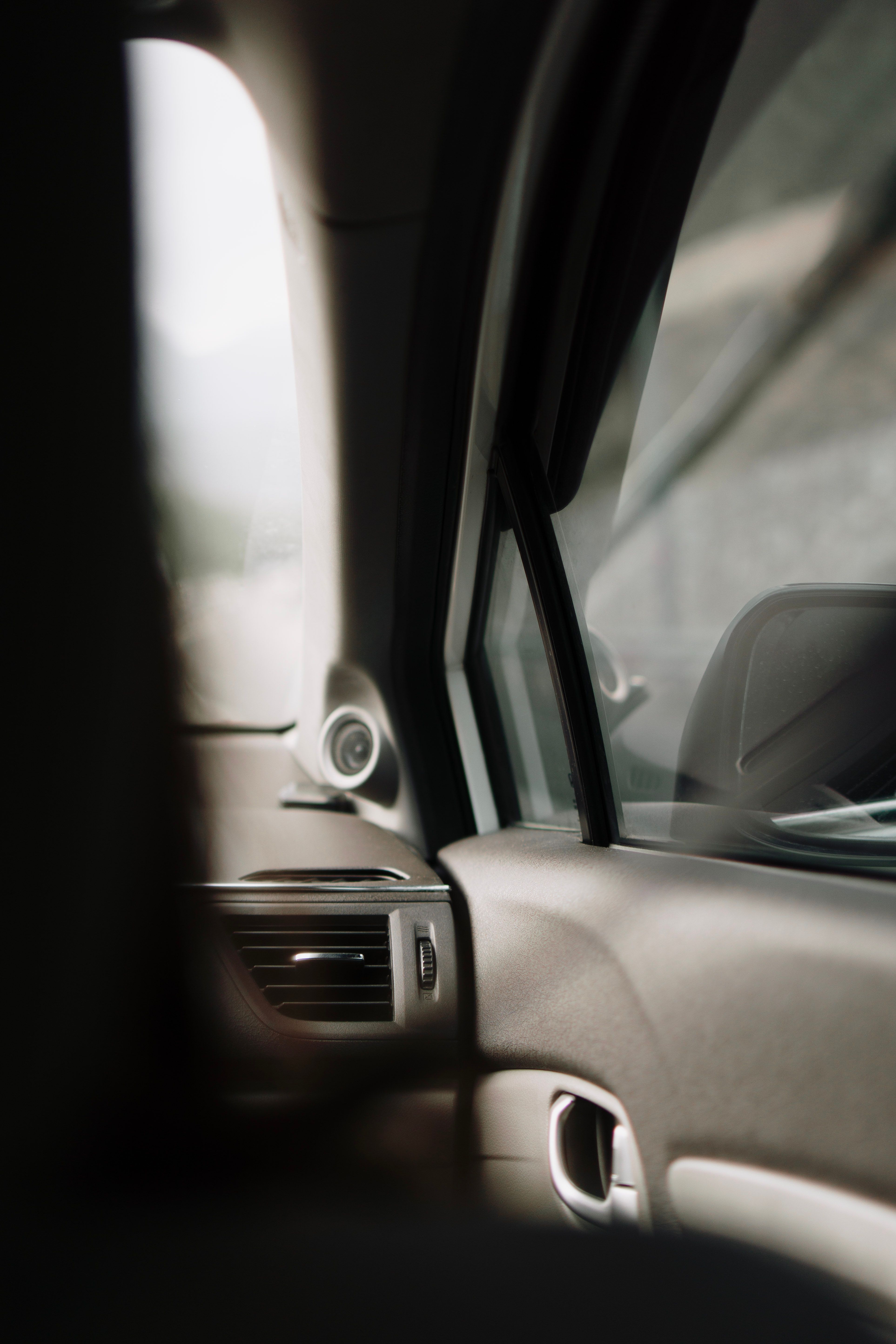 Car Interior View Through Side Window on a Cloudy Day · Free Stock Photo