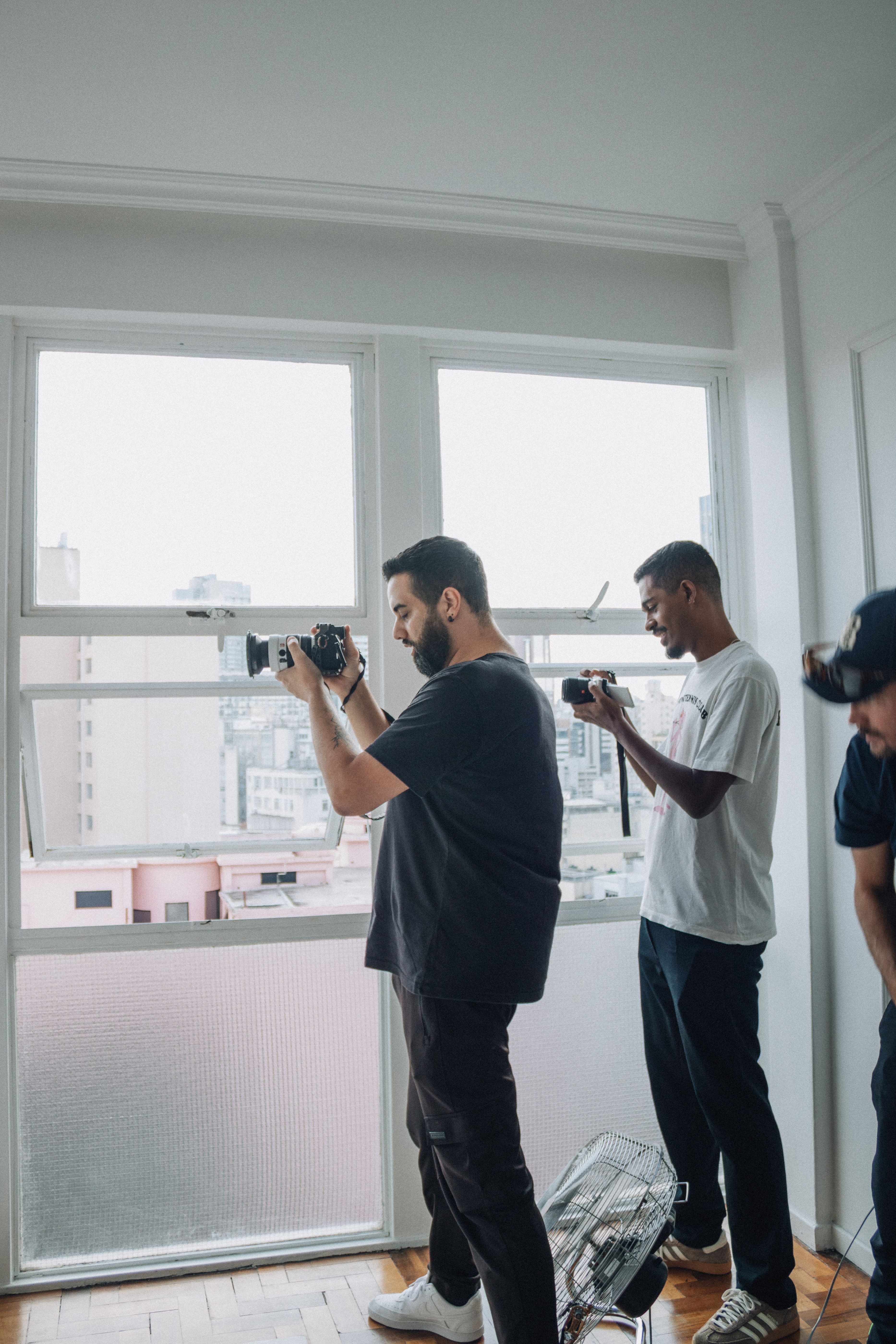 Group of Photographers Shooting in Studio Setting · Free Stock Photo