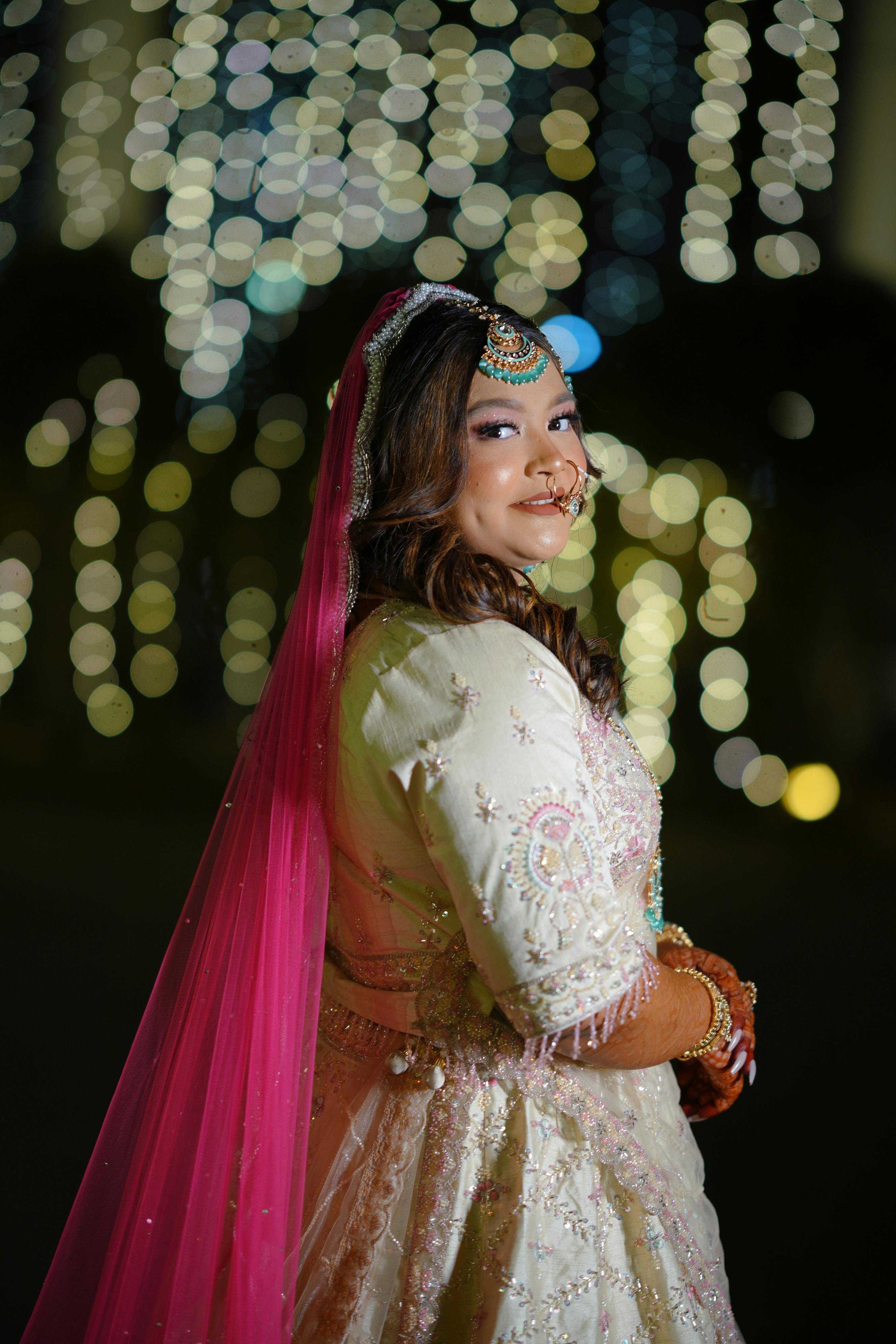 Elegant Bride in Traditional Attire with Bokeh Lights · Free Stock Photo