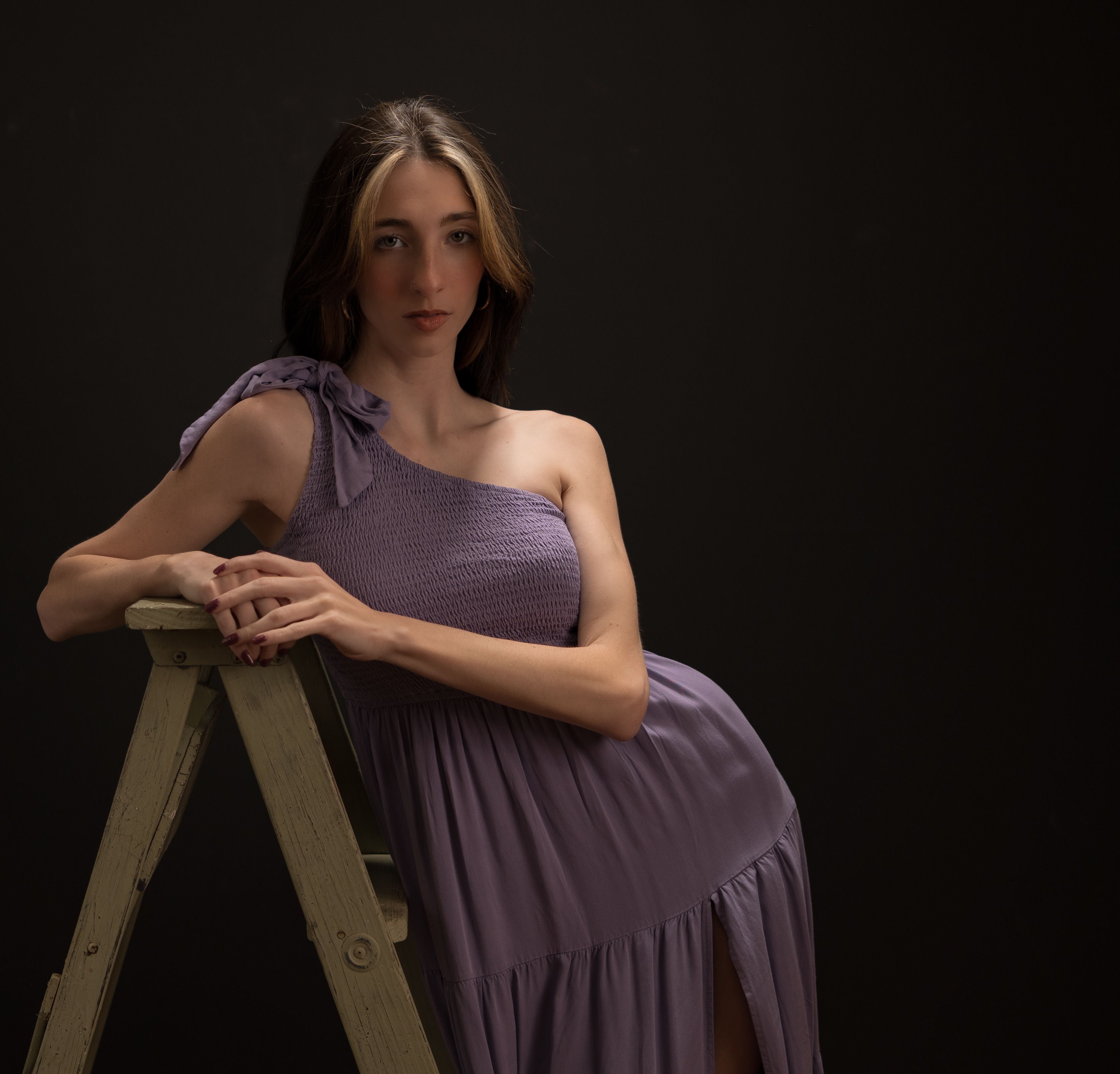 Elegant Woman in Lavender Dress on Ladder · Free Stock Photo