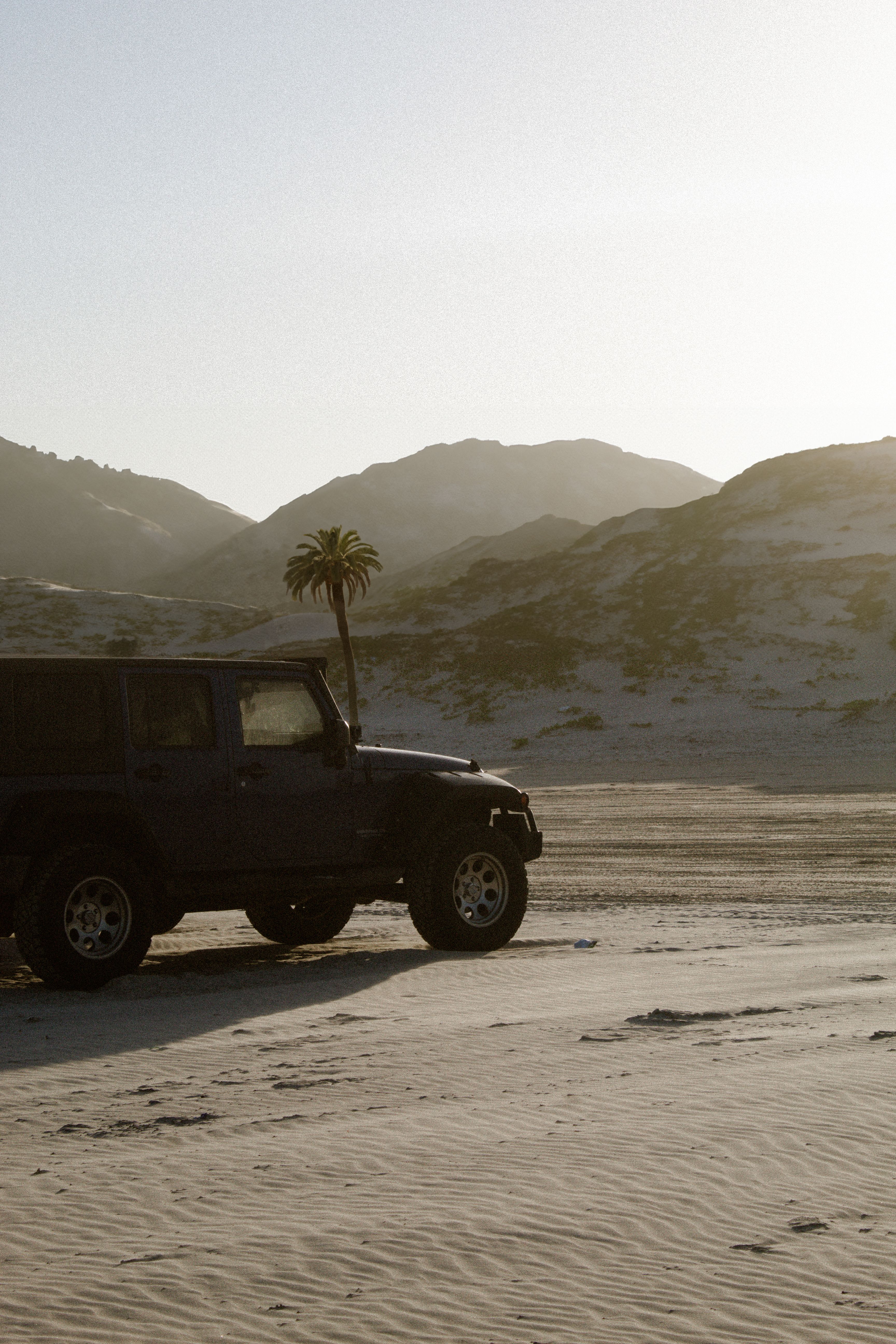 Off-Road Vehicle on Desert Terrain at Sunset · Free Stock Photo