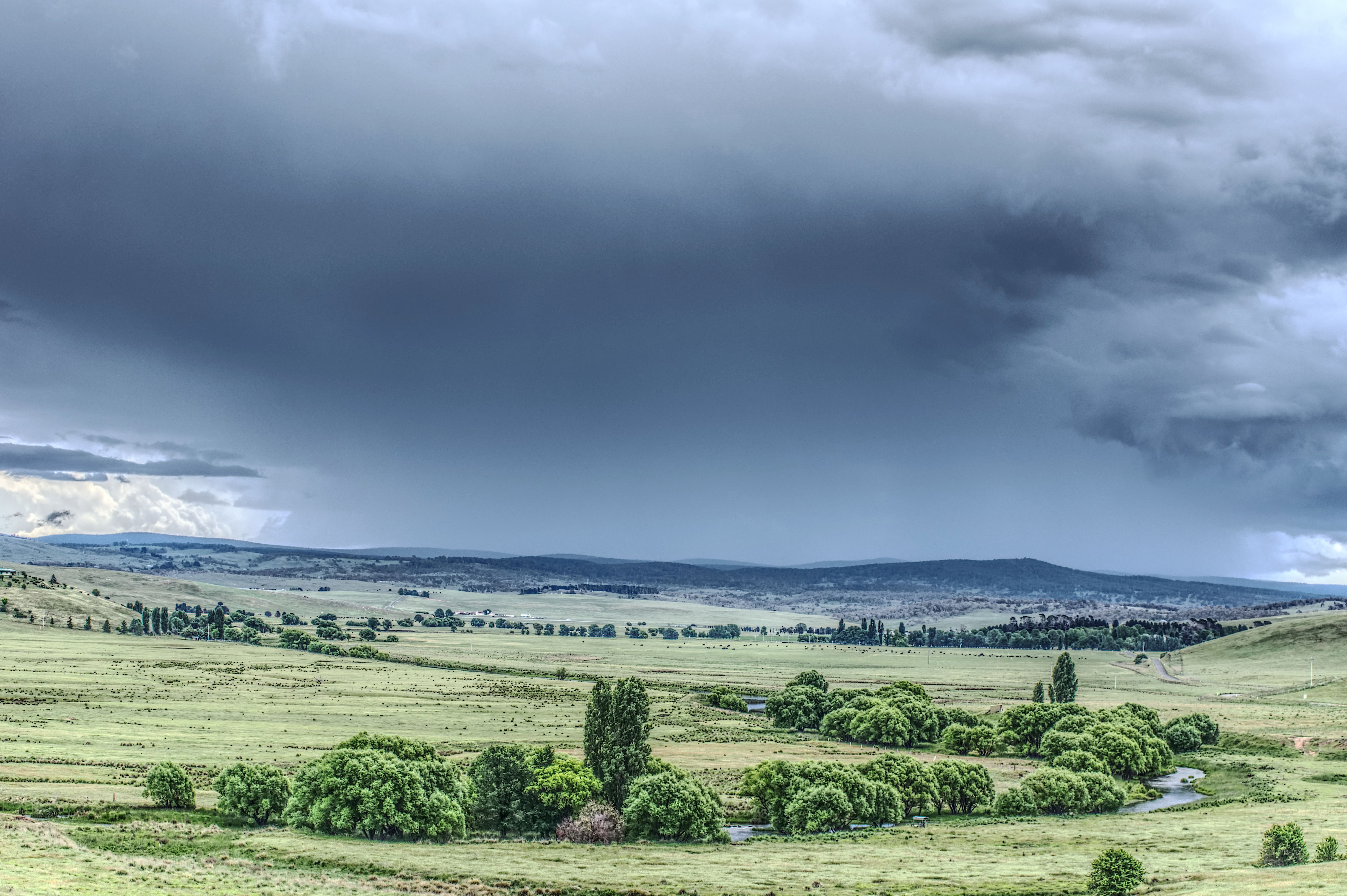 Dramatic Sky Over Lush Green Landscape · Free Stock Photo
