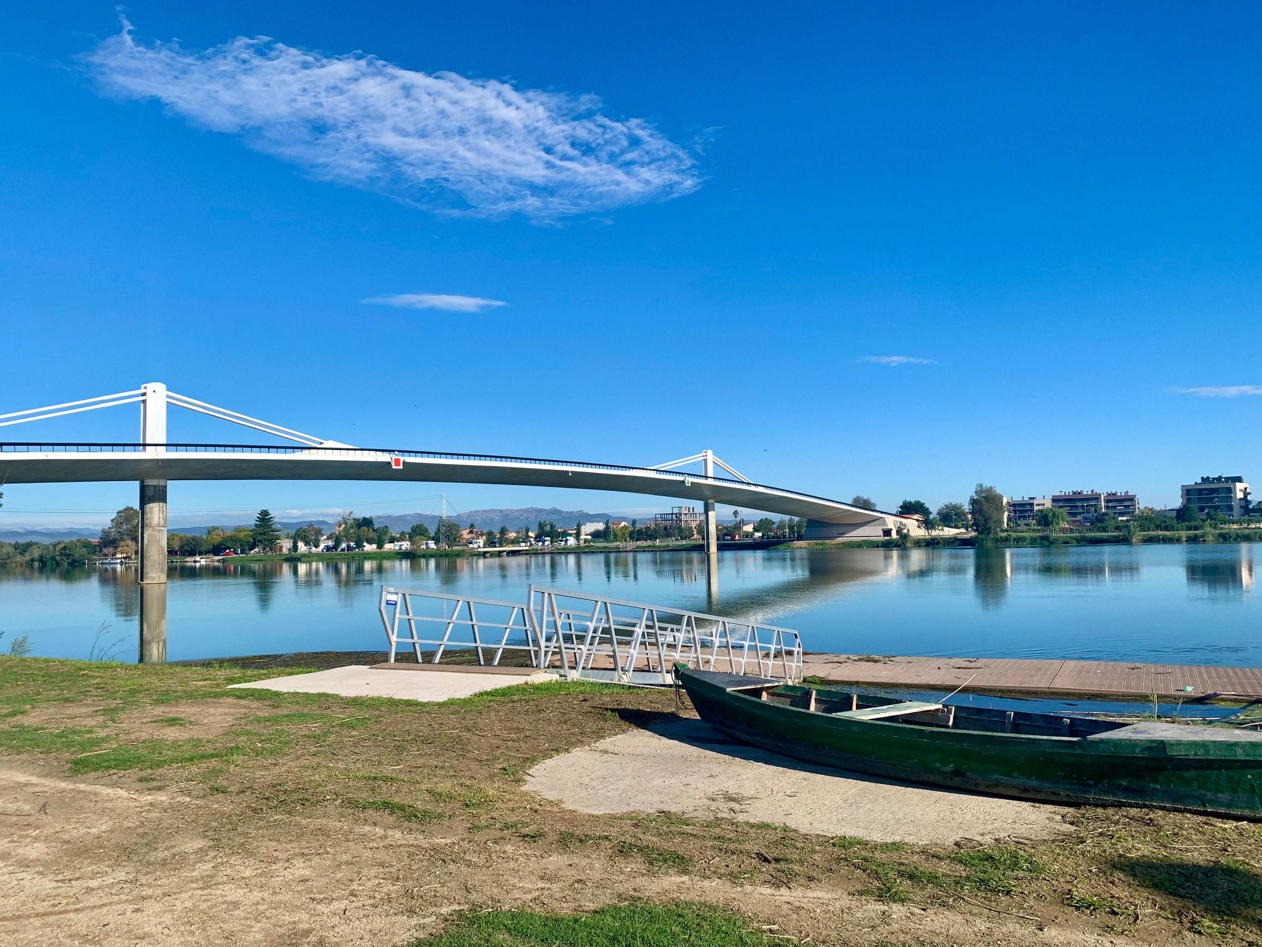 Modern Pedestrian Bridge Over Calm River · Free Stock Photo