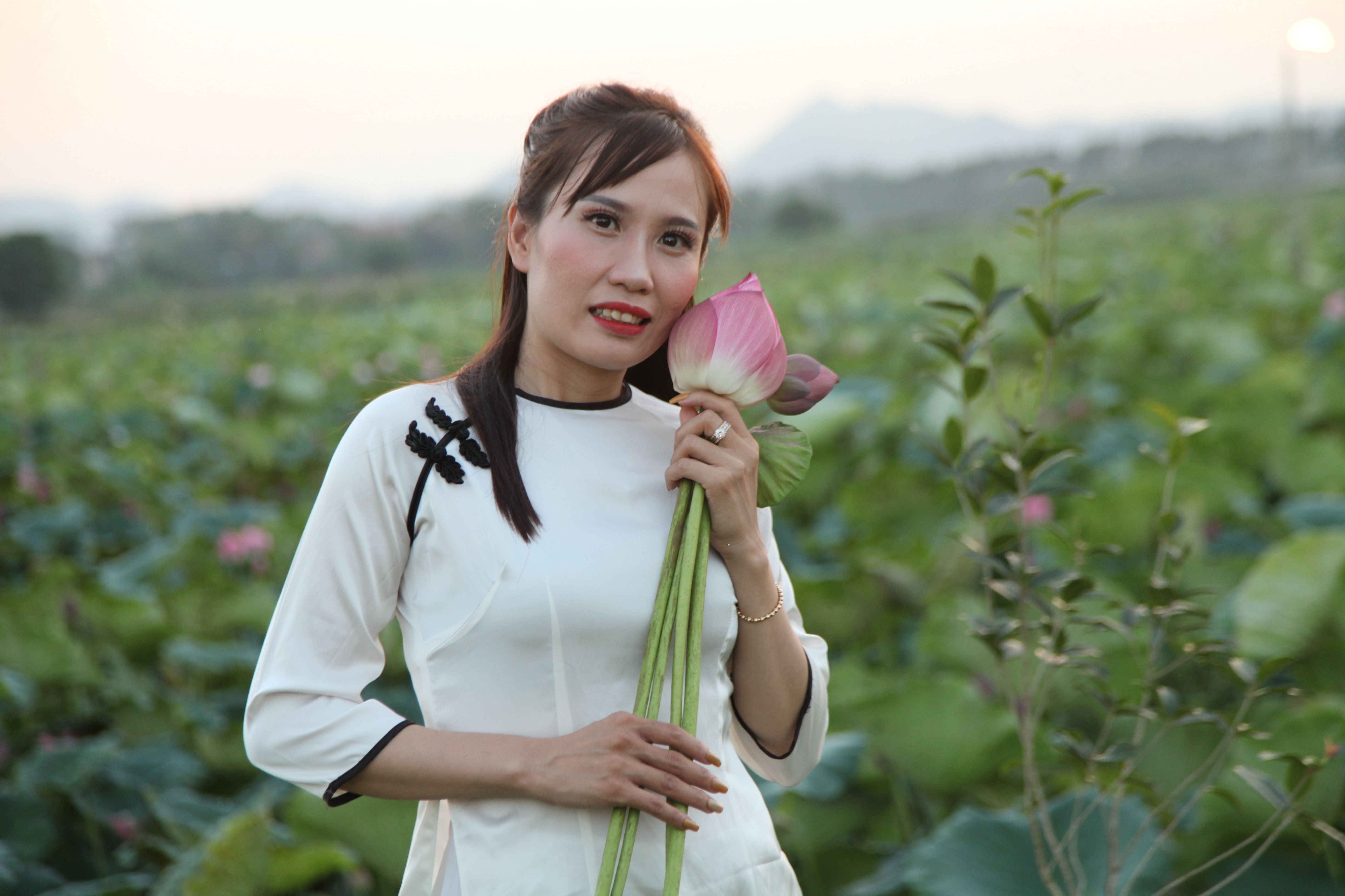 Woman Posing with Lotus Flowers in Field · Free Stock Photo