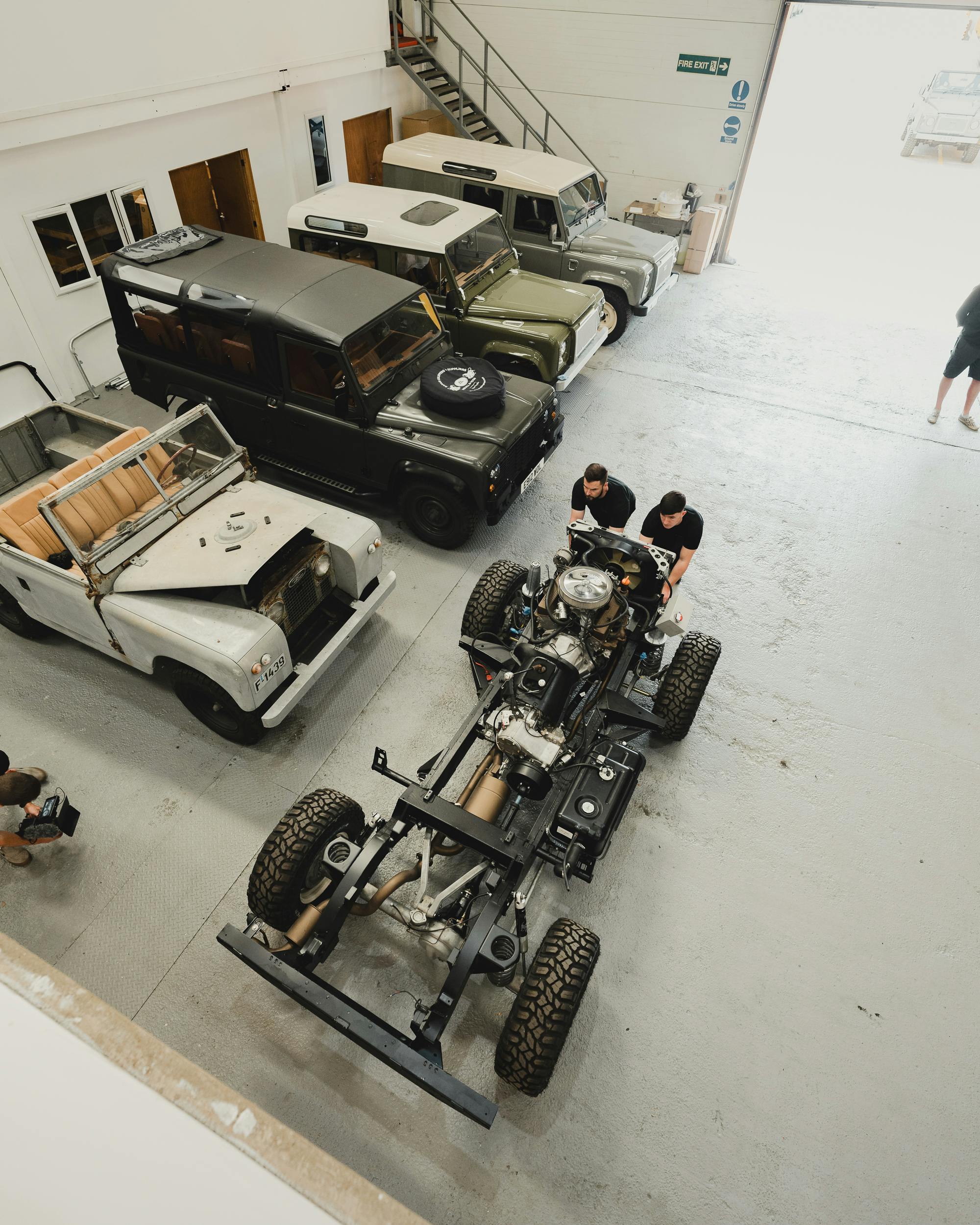 Mechanics Restoring Land Rover in Workshop · Free Stock Photo