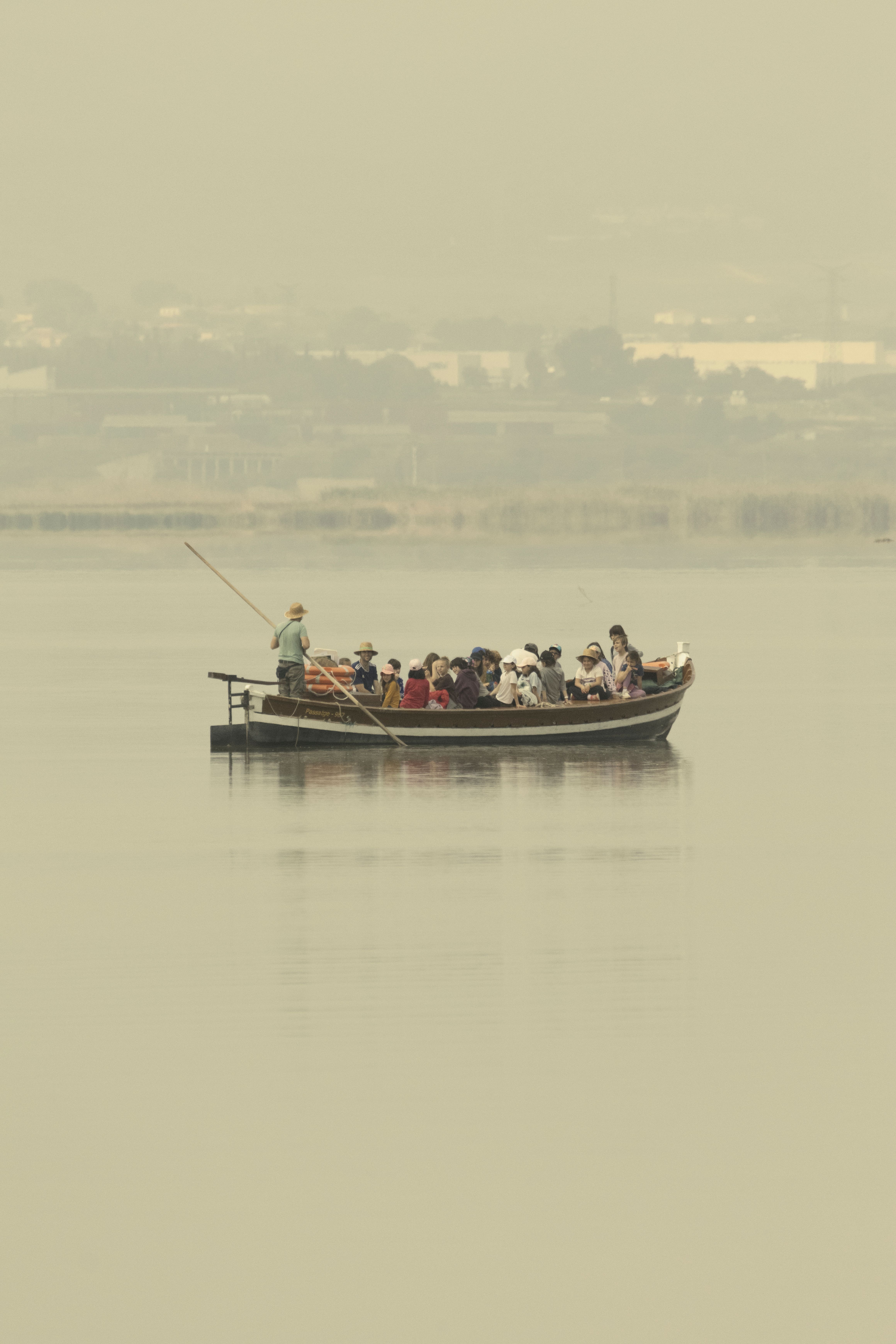 Tranquil Boat Journey on Misty Lake · Free Stock Photo