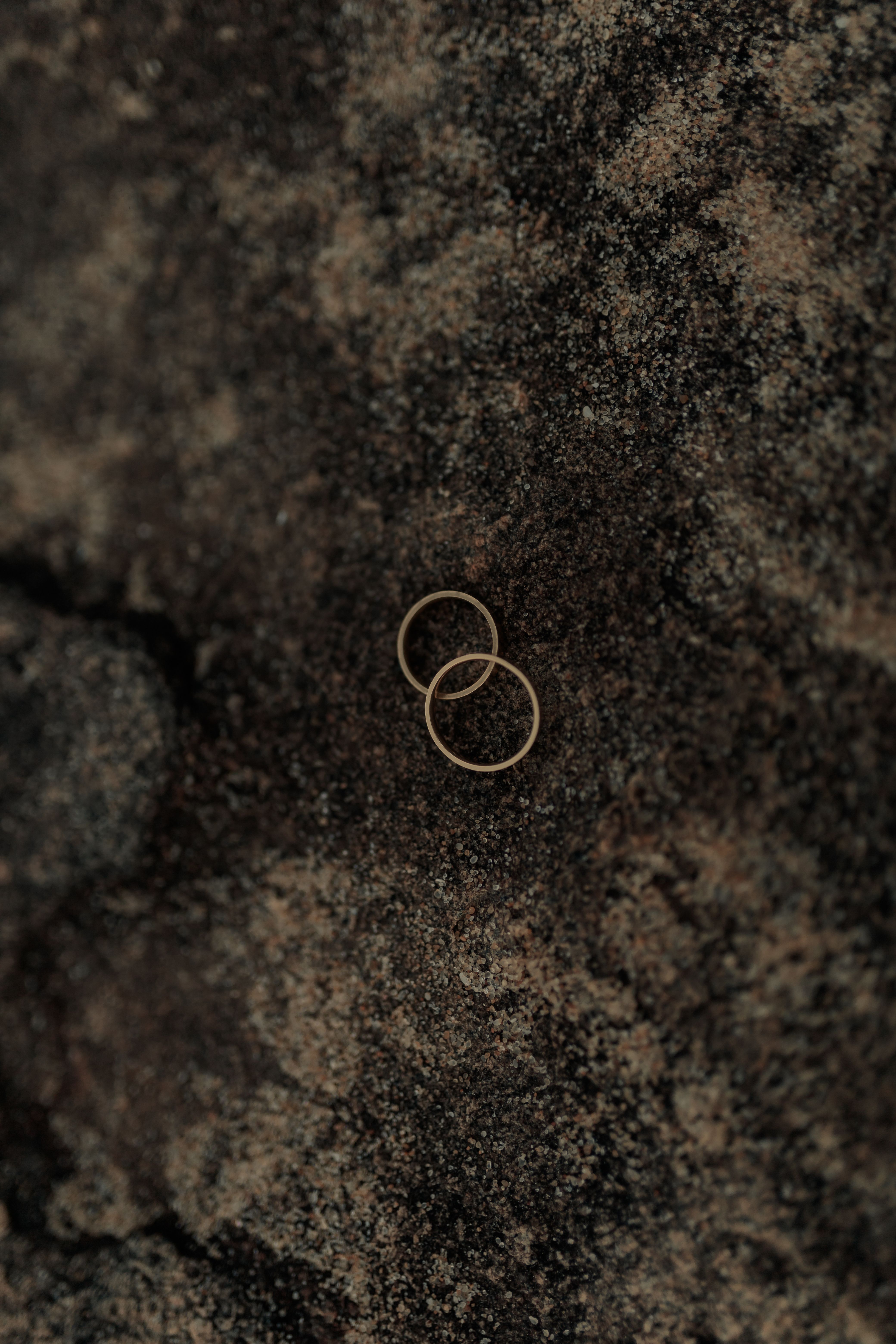 Minimalist Wedding Rings on Textured Stone Surface · Free Stock Photo