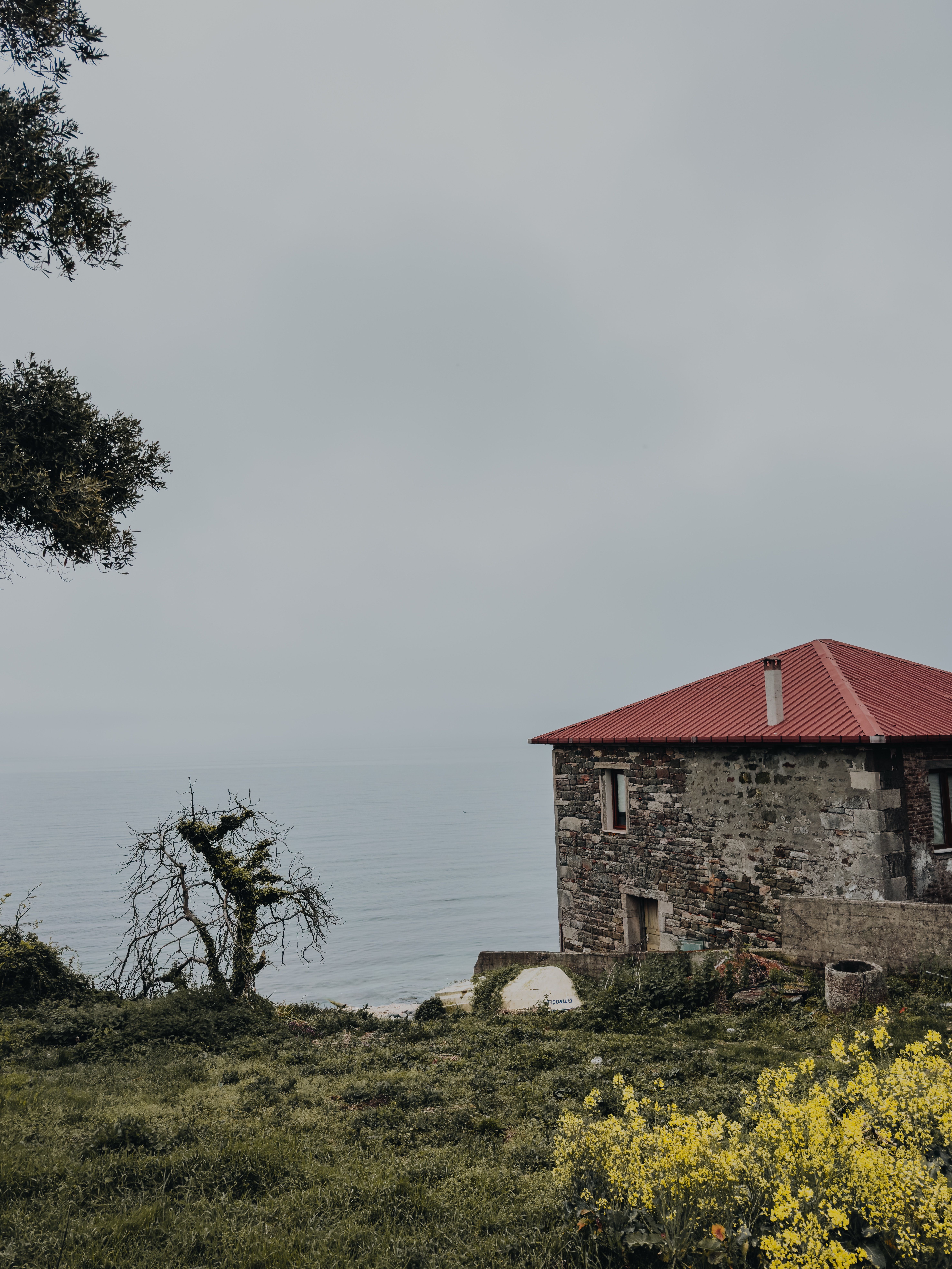 Coastal Stone House with Red Roof in Spring Landscape · Free Stock Photo