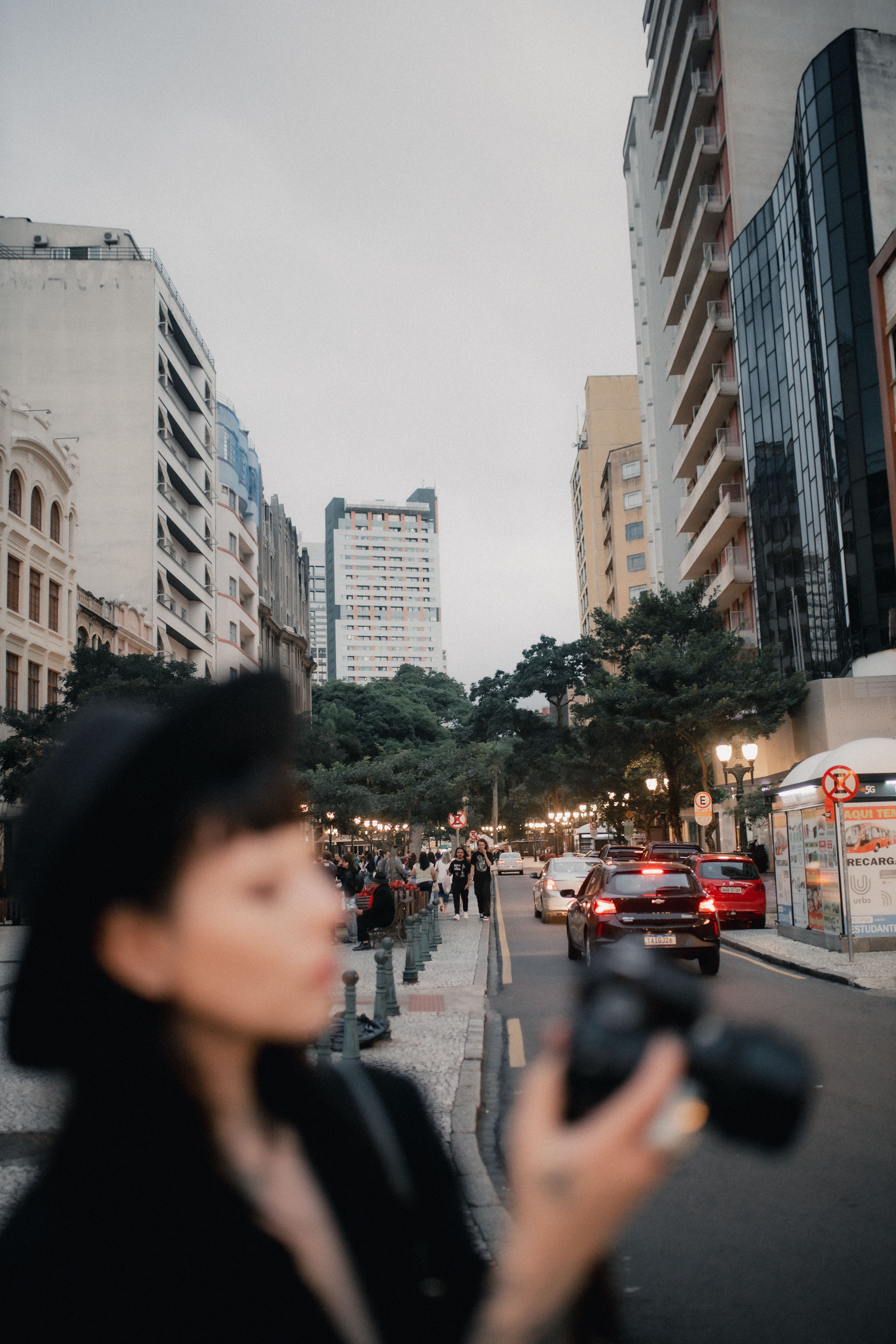 Photographer in Vibrant City Street Scene · Free Stock Photo