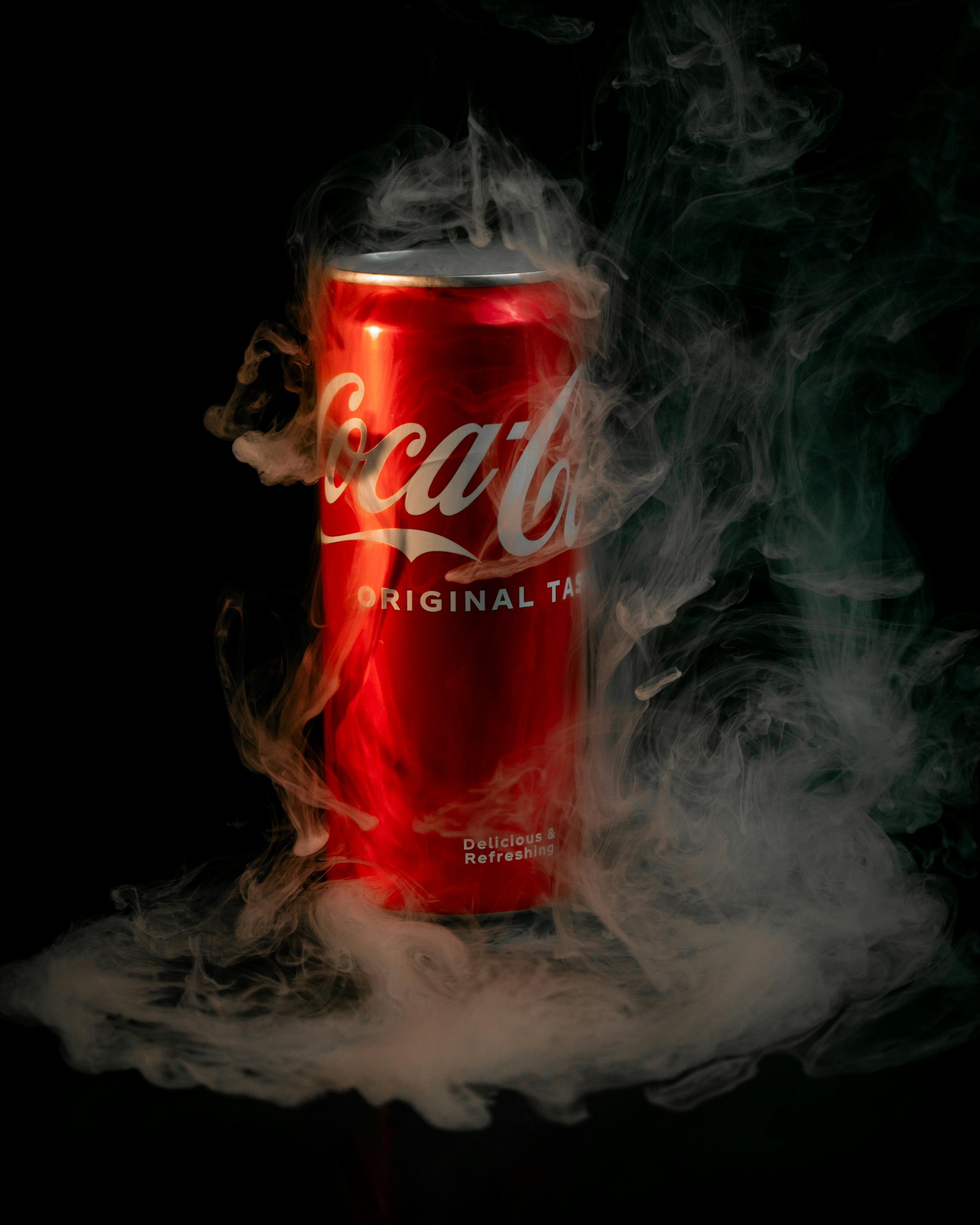 Dynamic Coca-Cola Can in Smoke on Black Background · Free Stock Photo