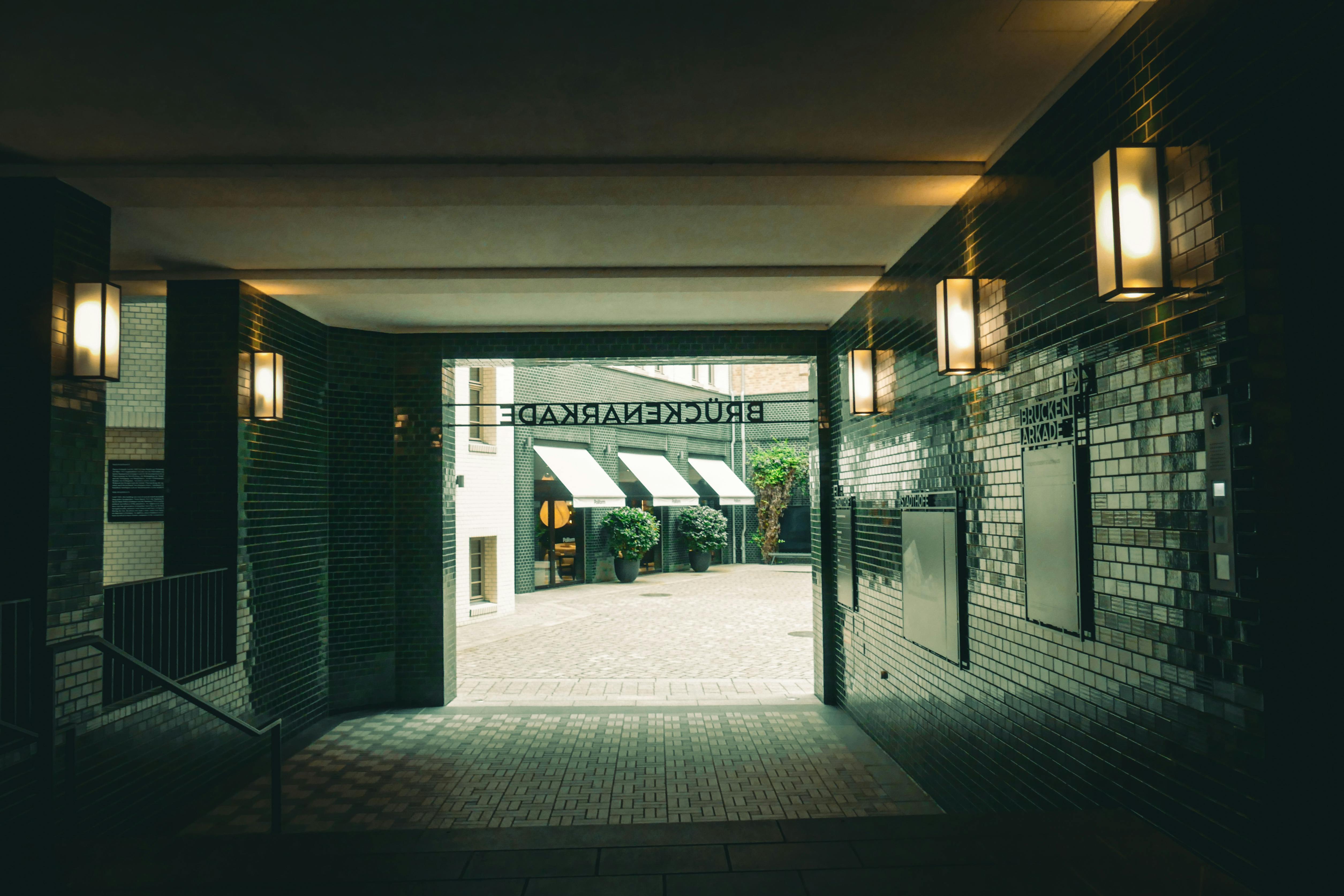 Elegant Arcade View with Illuminated Passage · Free Stock Photo