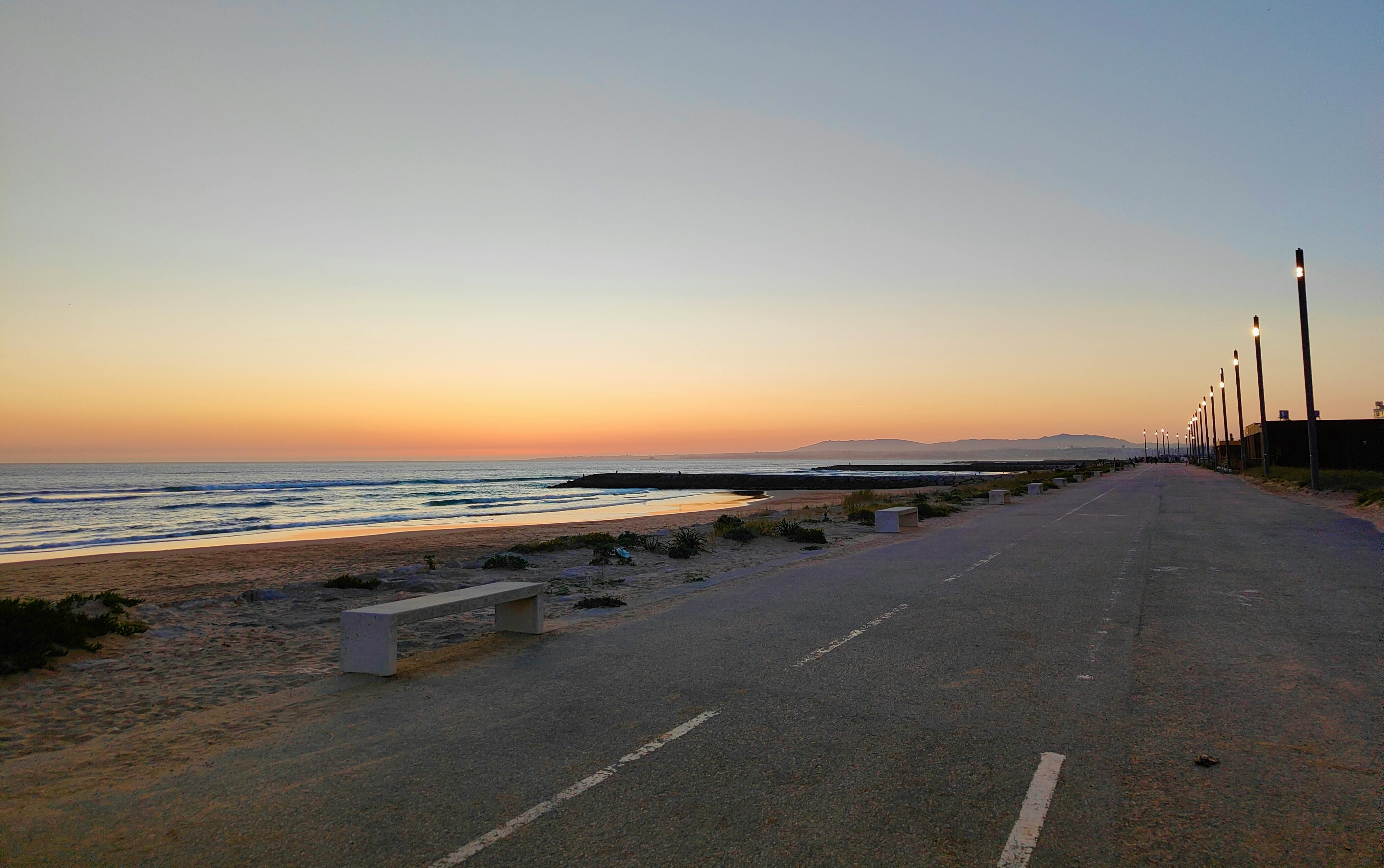 Serene Beach Sunset with Empty Promenade · Free Stock Photo