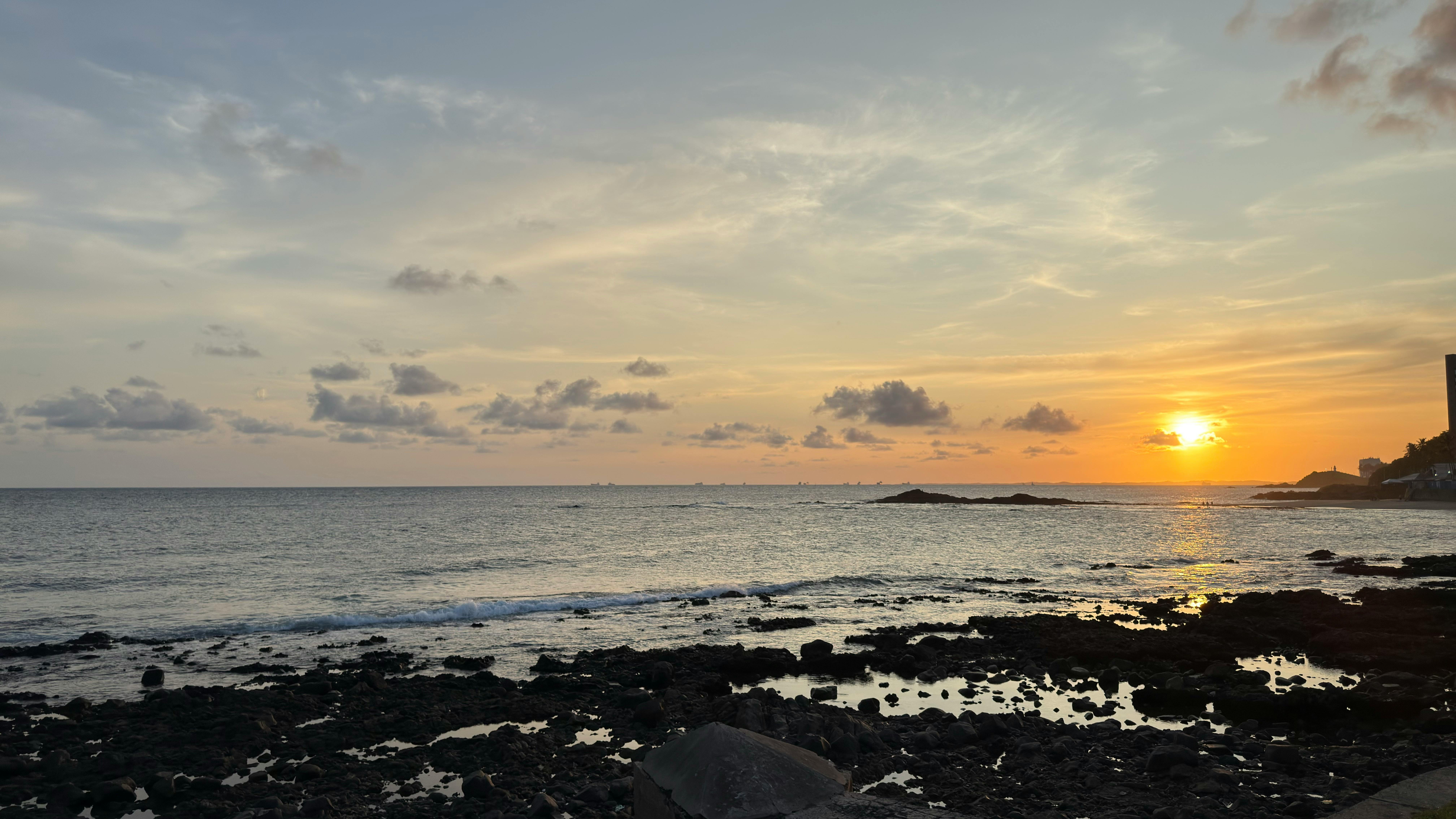 Stunning Sunset Over Rocky Ocean Shoreline · Free Stock Photo