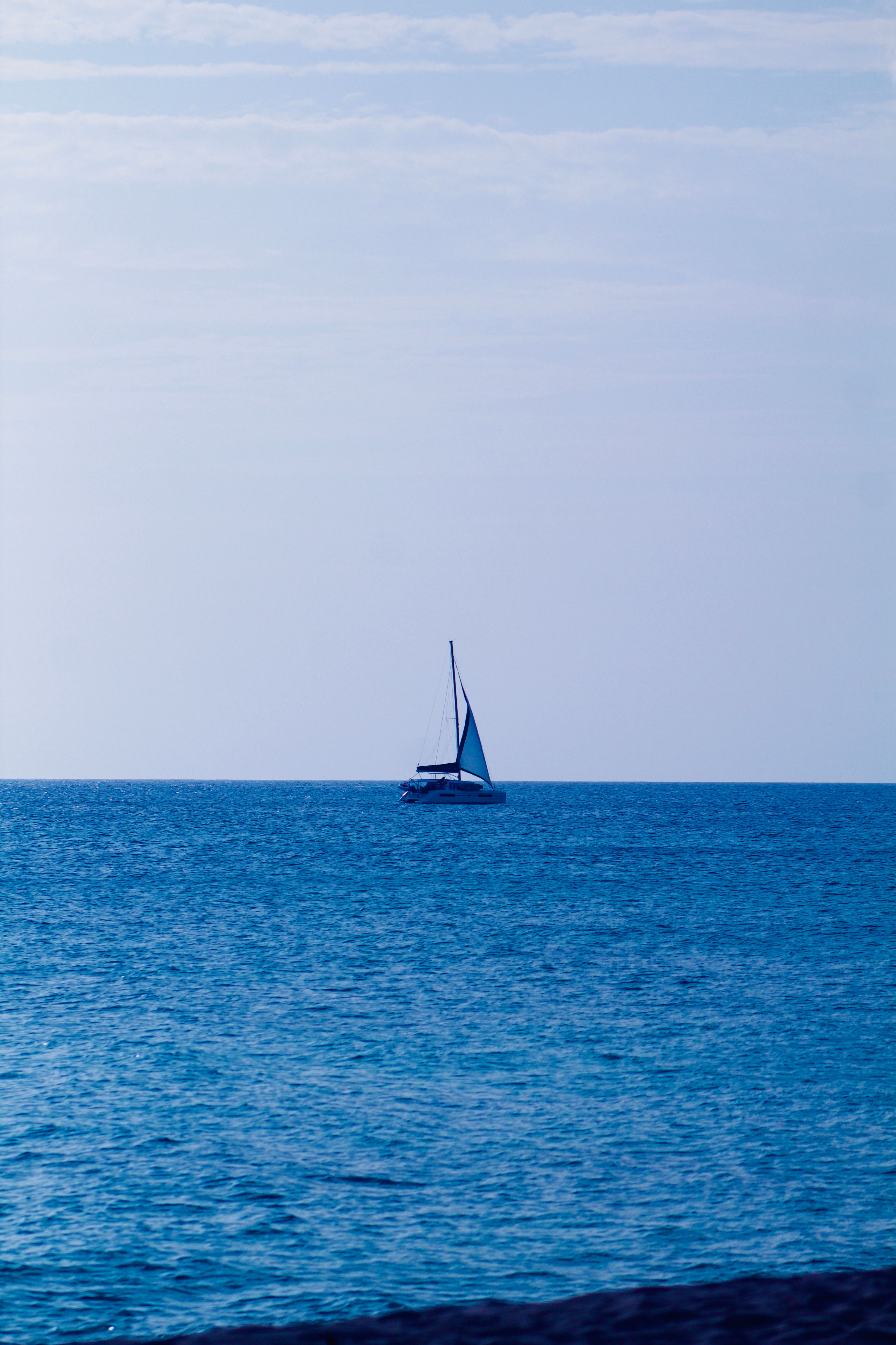 Serene Sailing Boat on Calm Blue Ocean Waters · Free Stock Photo