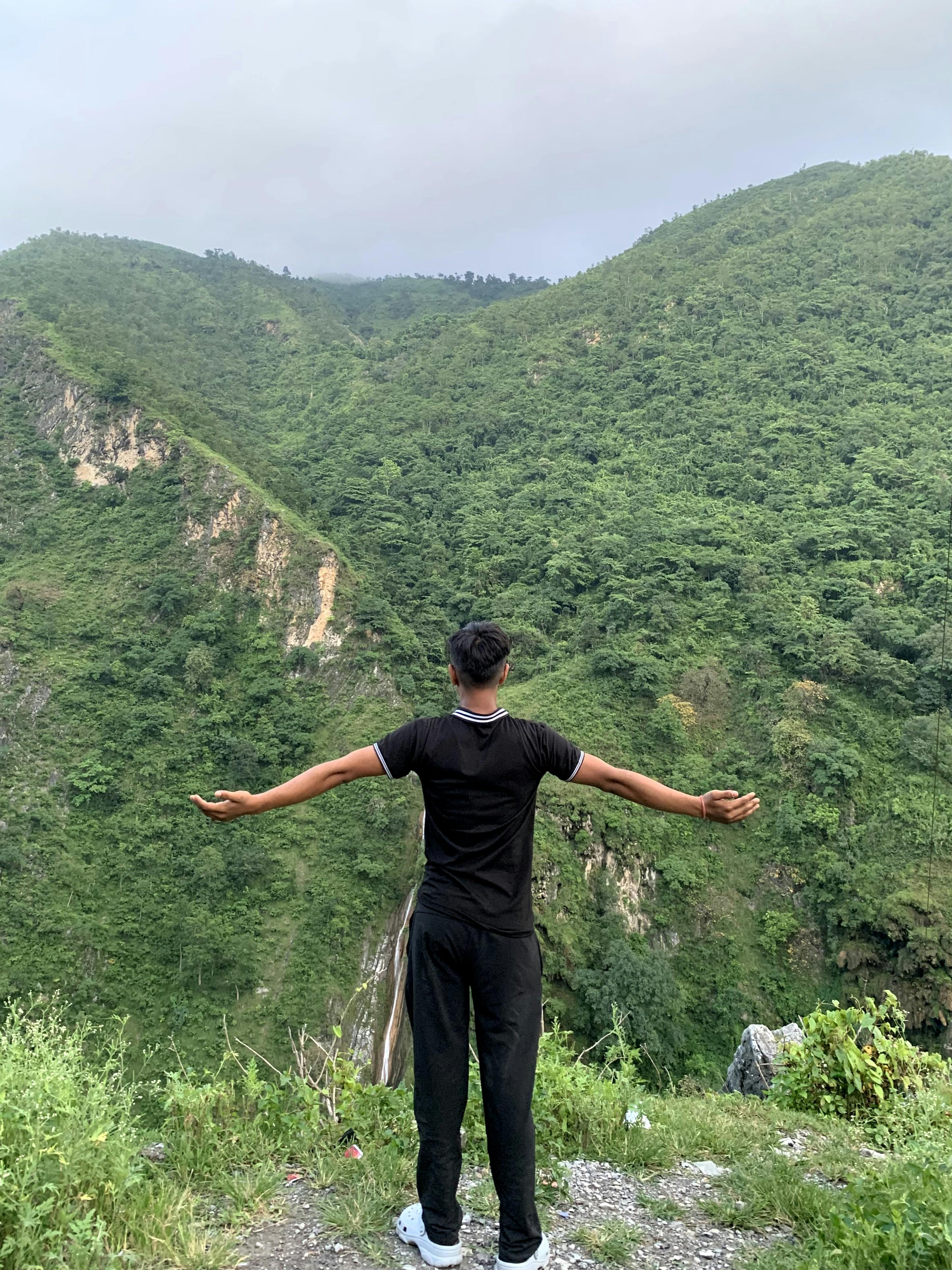 Man Embracing Nature From a Mountain Viewpoint · Free Stock Photo