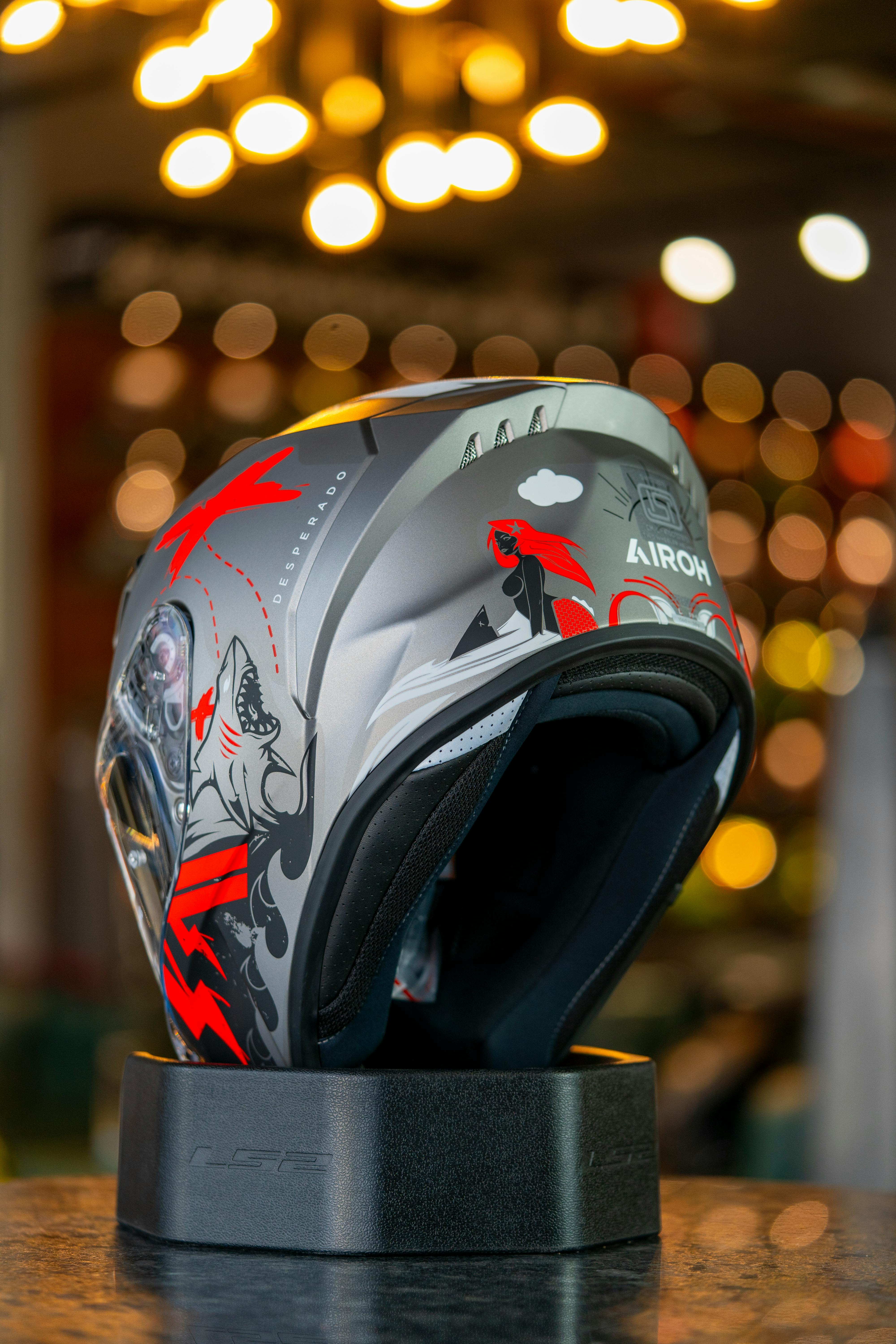 Colorful Motorcycle Helmet Display with Artistic Design · Free Stock Photo