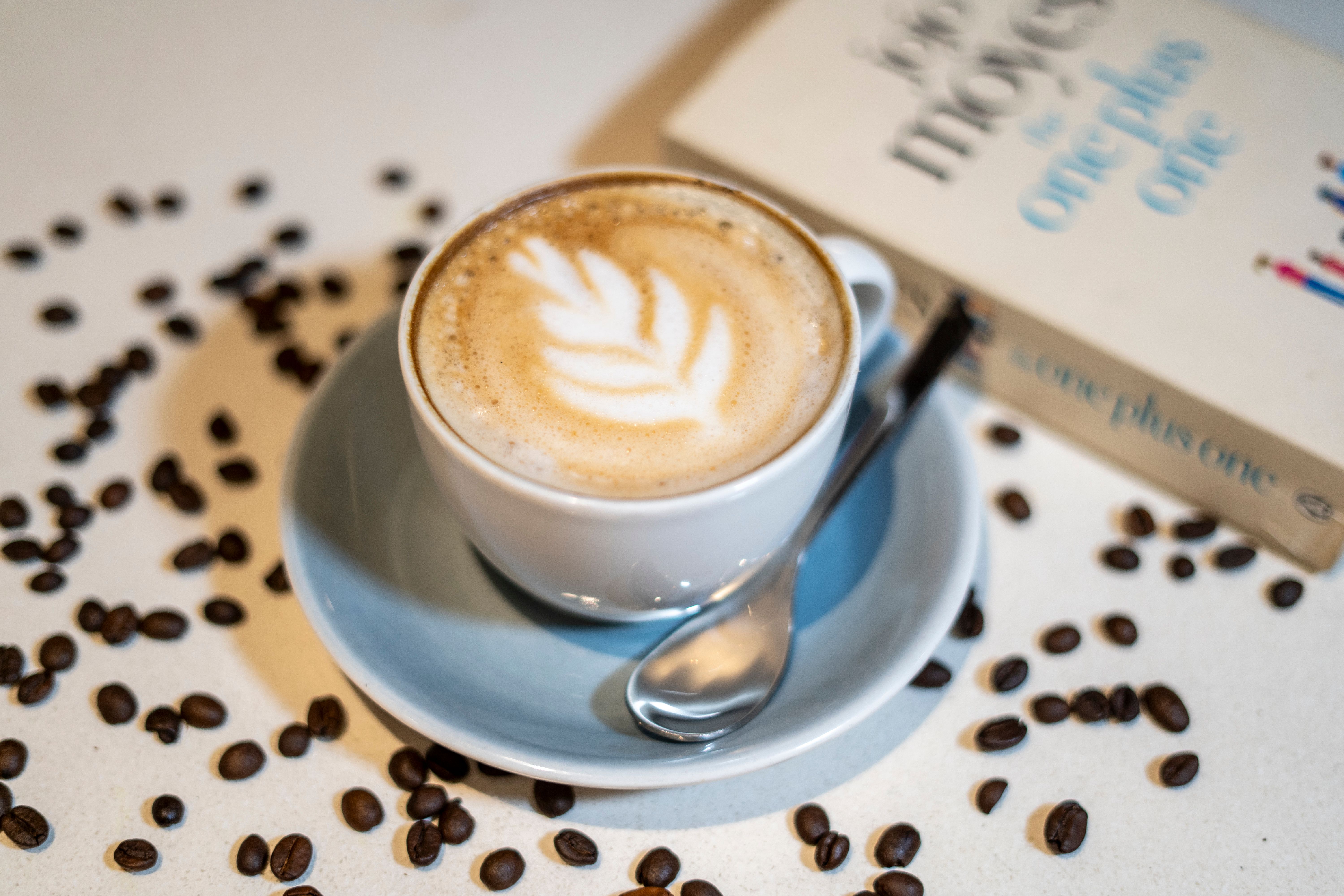 Artistic Latte in Cozy Coffee Shop Setting · Free Stock Photo