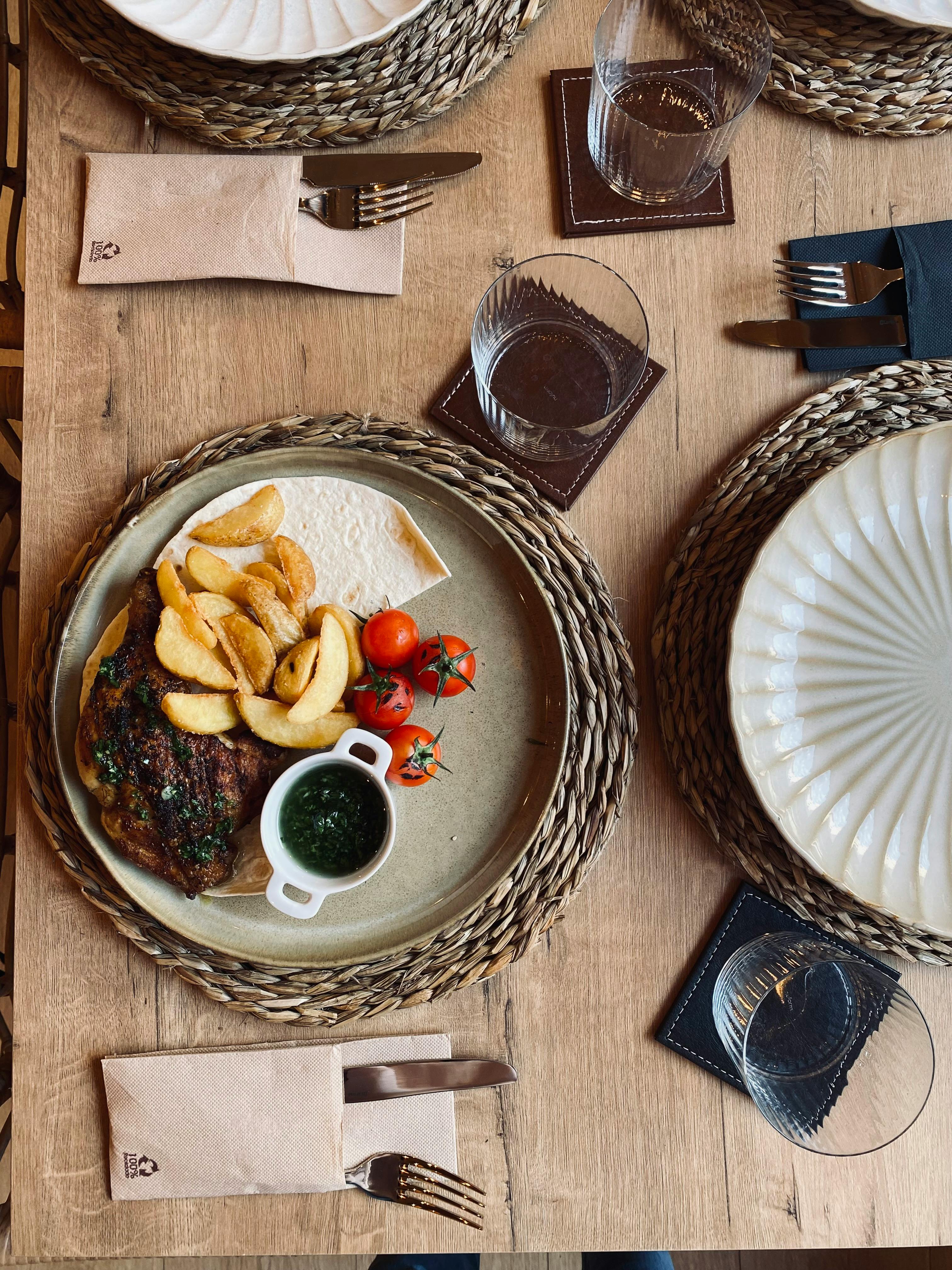 Rustic Dining Setup with Steak and Wedges · Free Stock Photo