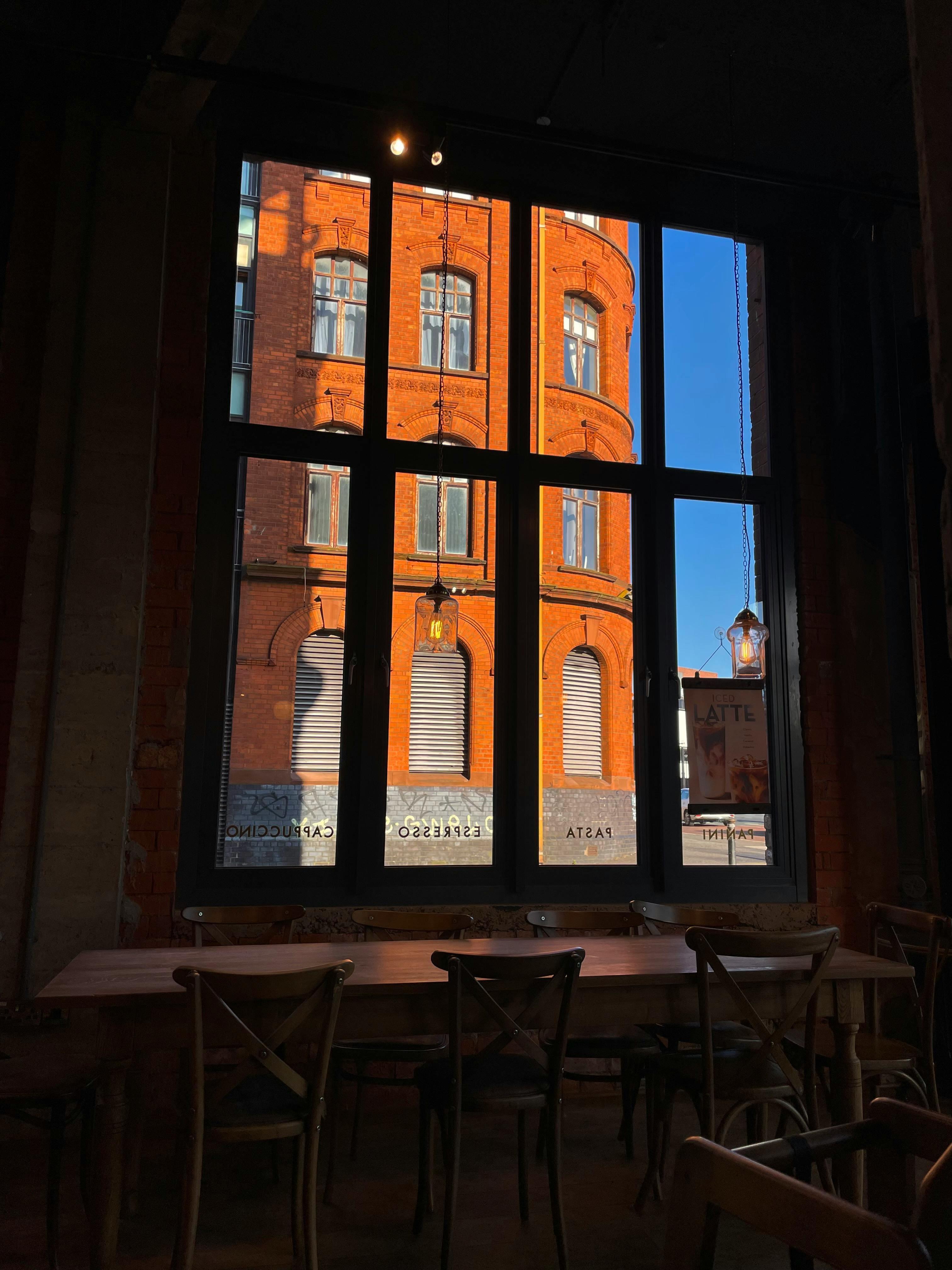 Cafe Interior with Urban View Through Window · Free Stock Photo
